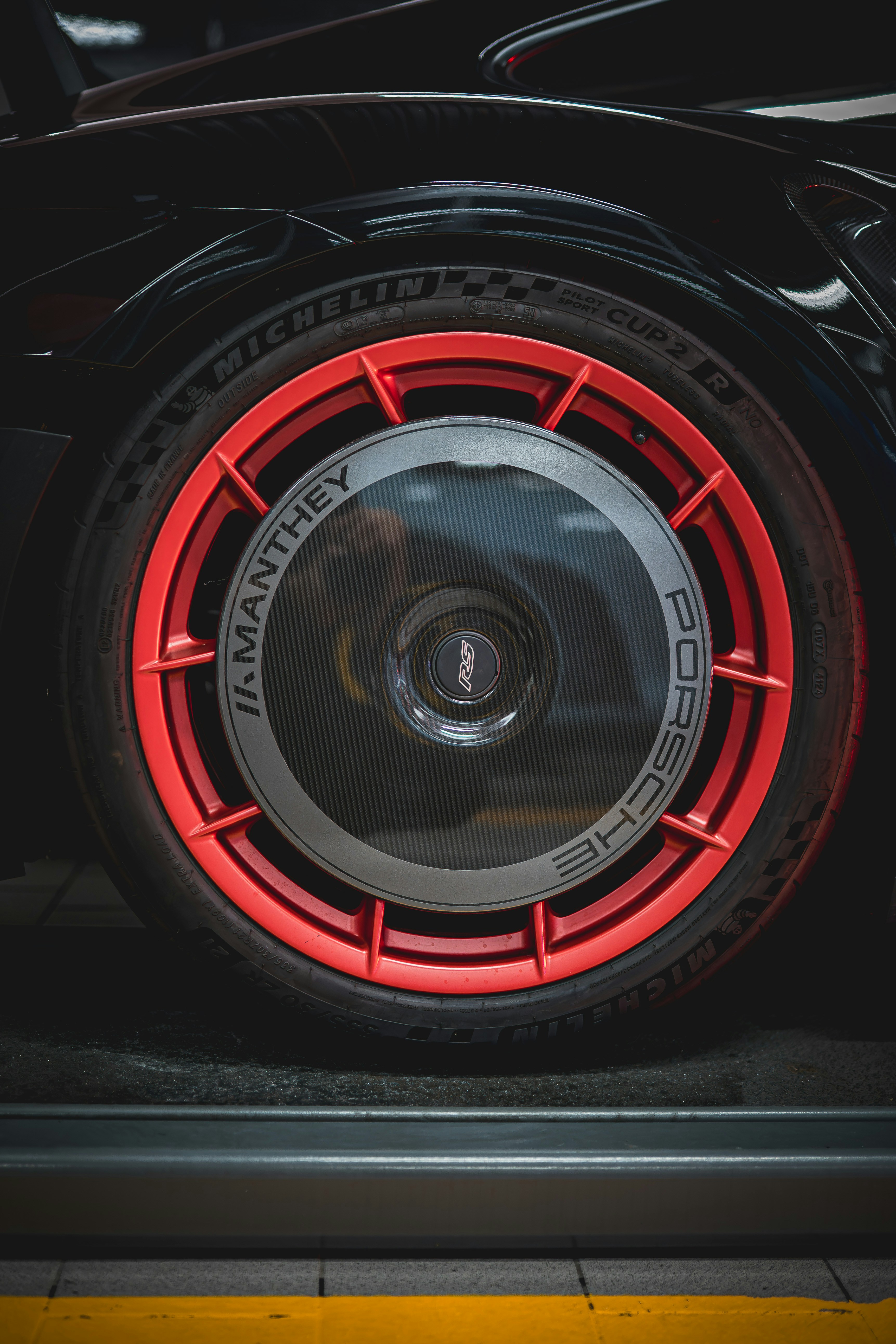 Red Rim Portrait: Porsche Wheel in Quiet Focus
