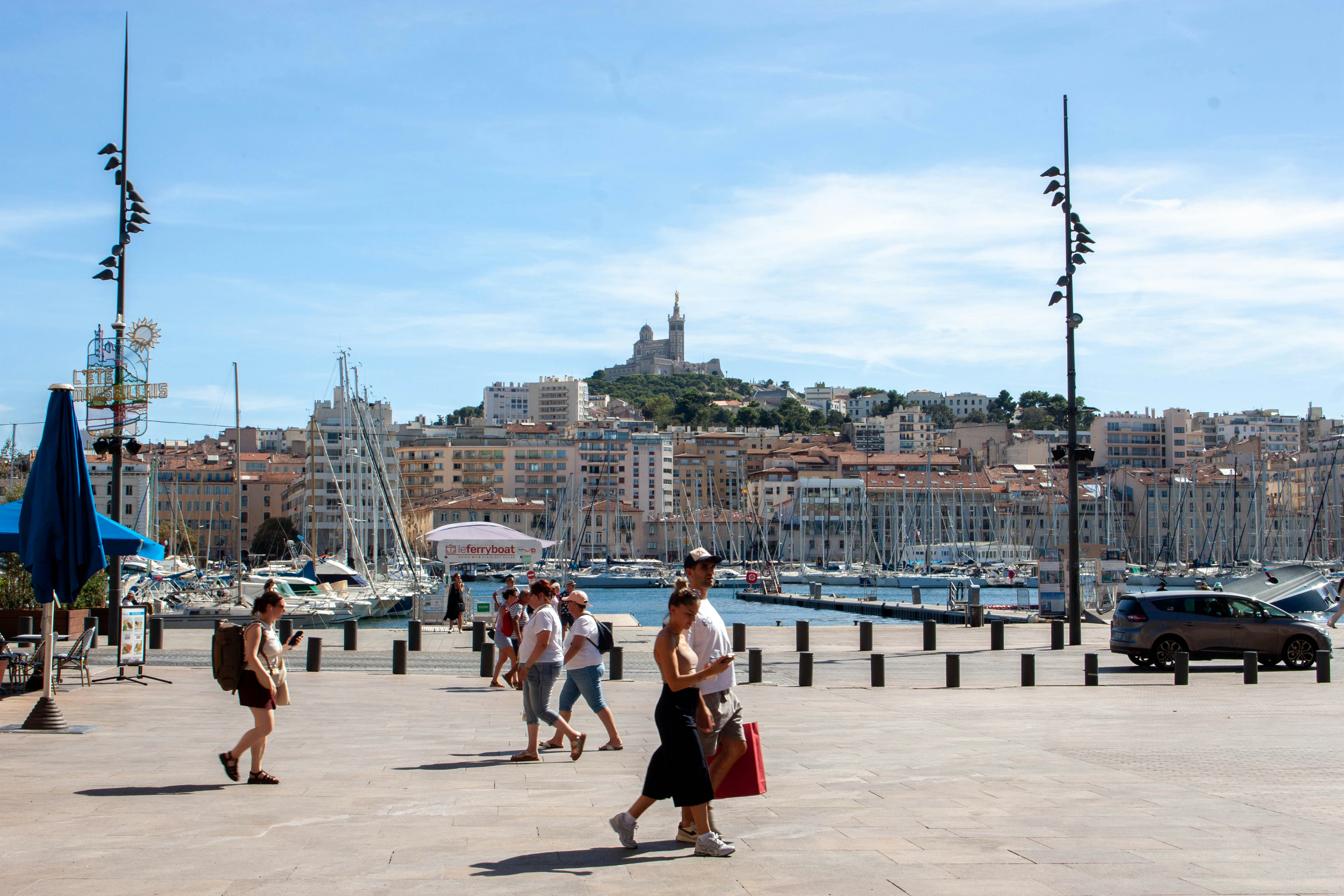 Harbor Promenade: People and Boats Under a Coastal Skyline