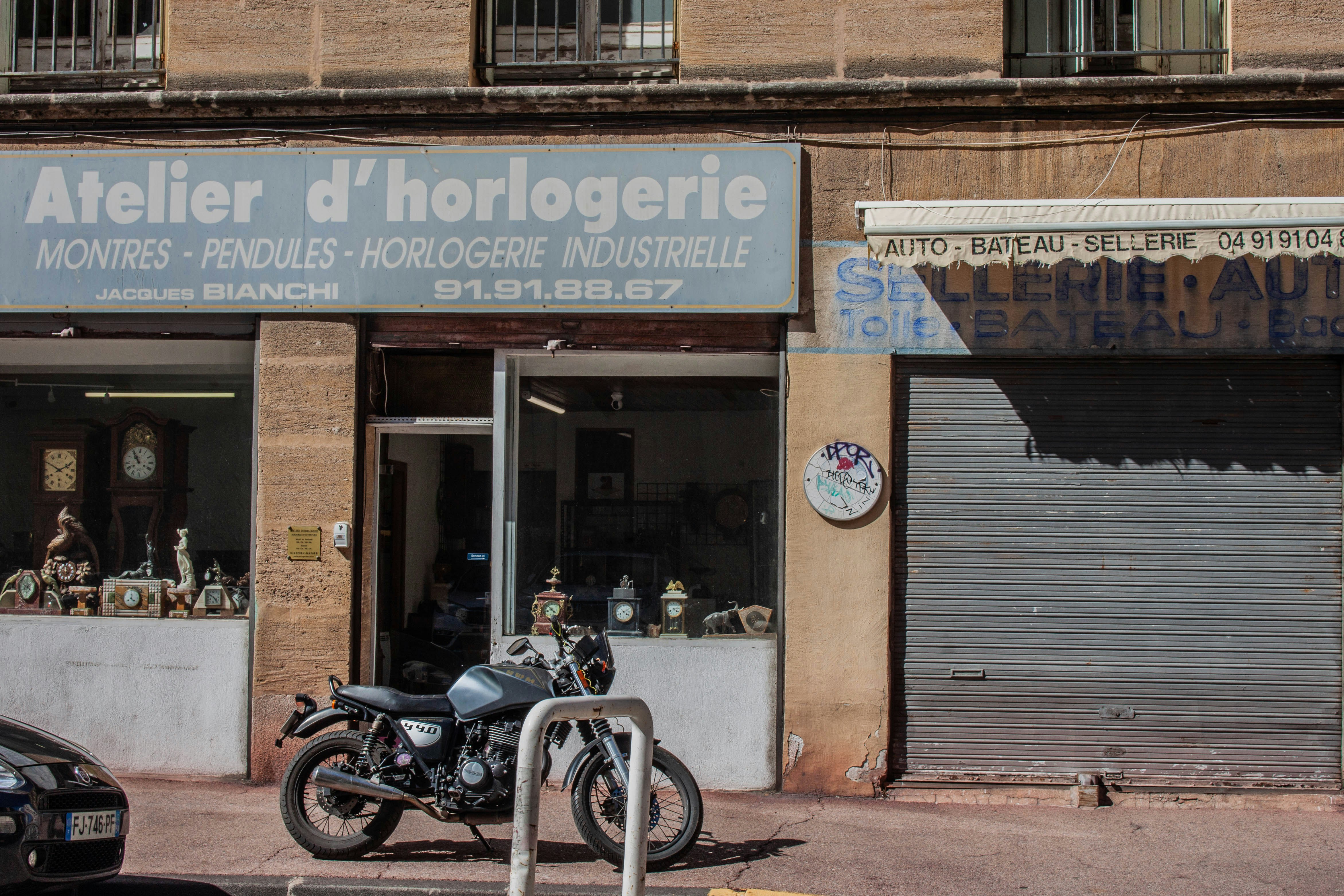 Street-side Workshop: Antique Clock Shop and Resting Motorbike
