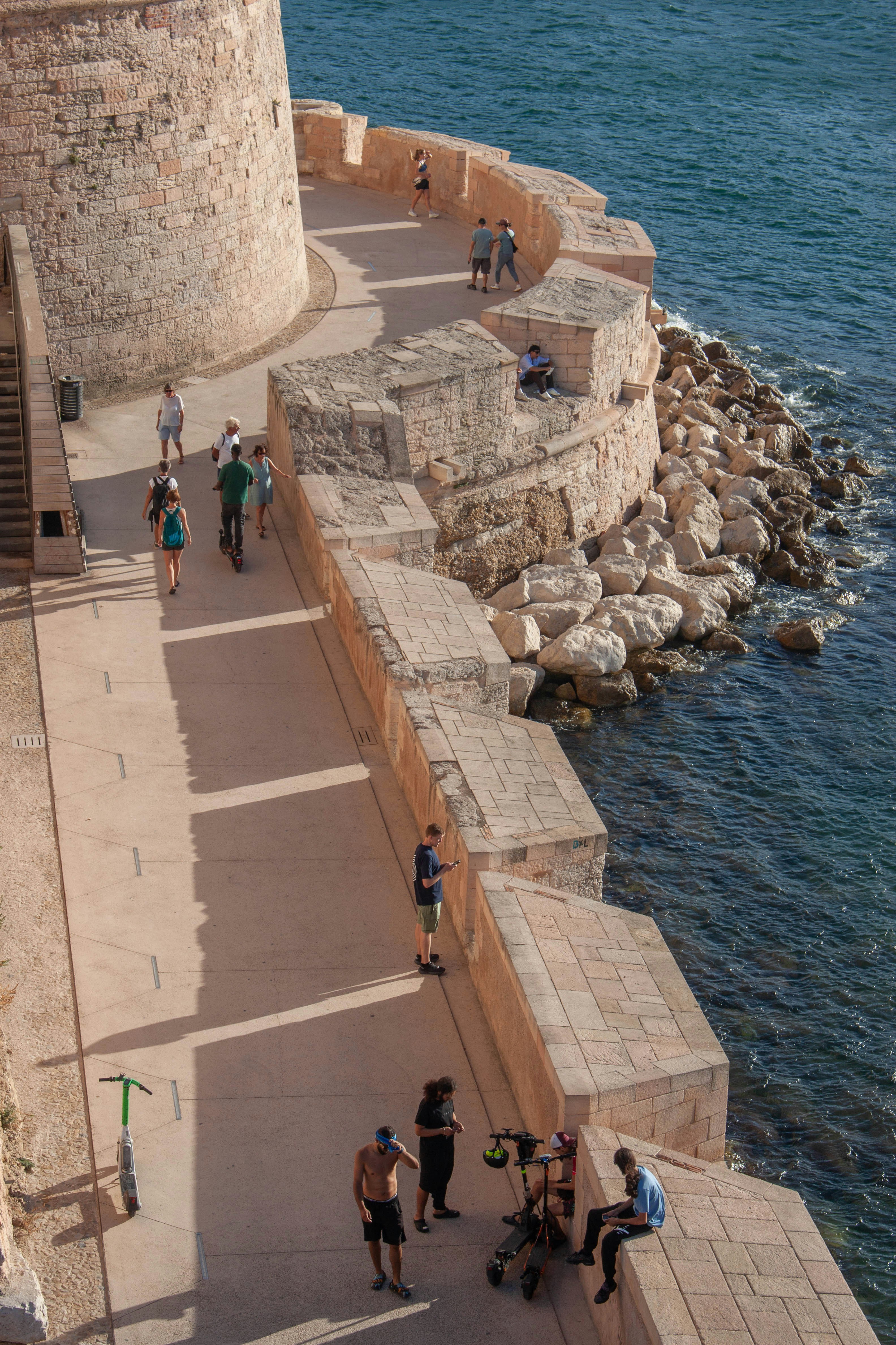 Harborwalk Echo: Tourists on the Circular Bastion by the Sea