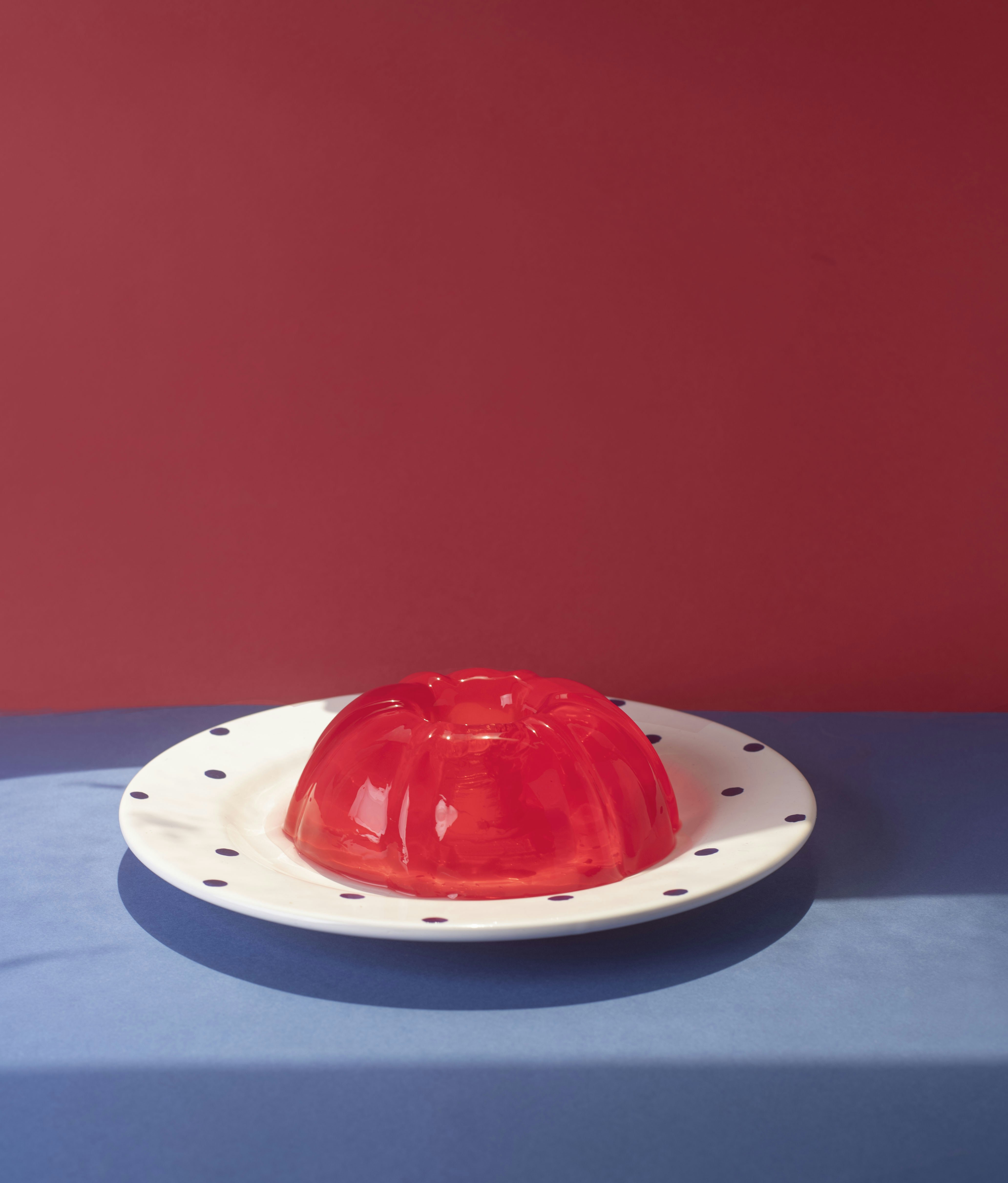 Red Gelatin Burst on a Polka-Dotted Plate