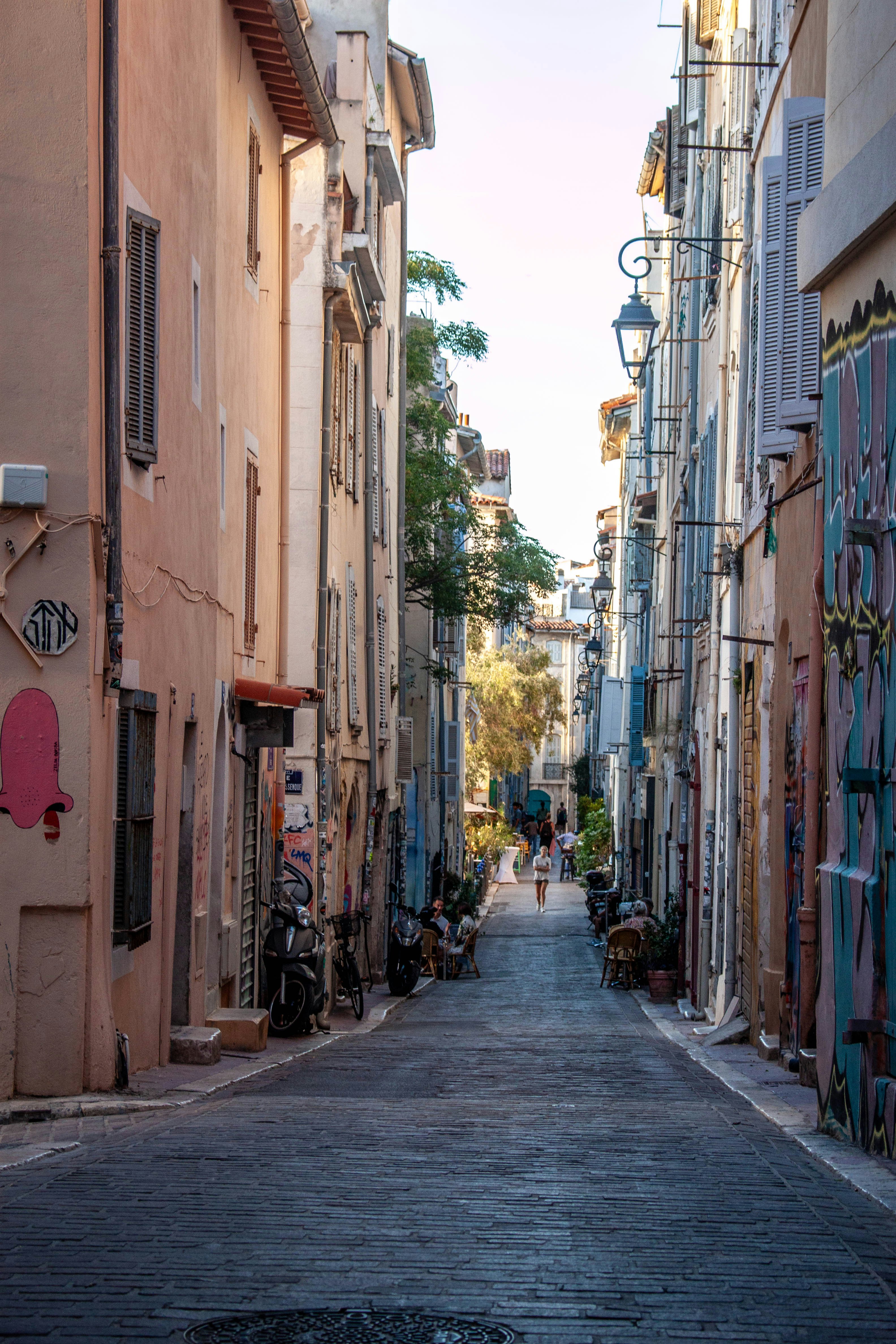 Cobbled Alleyway Teeming with Color and Quiet Motion