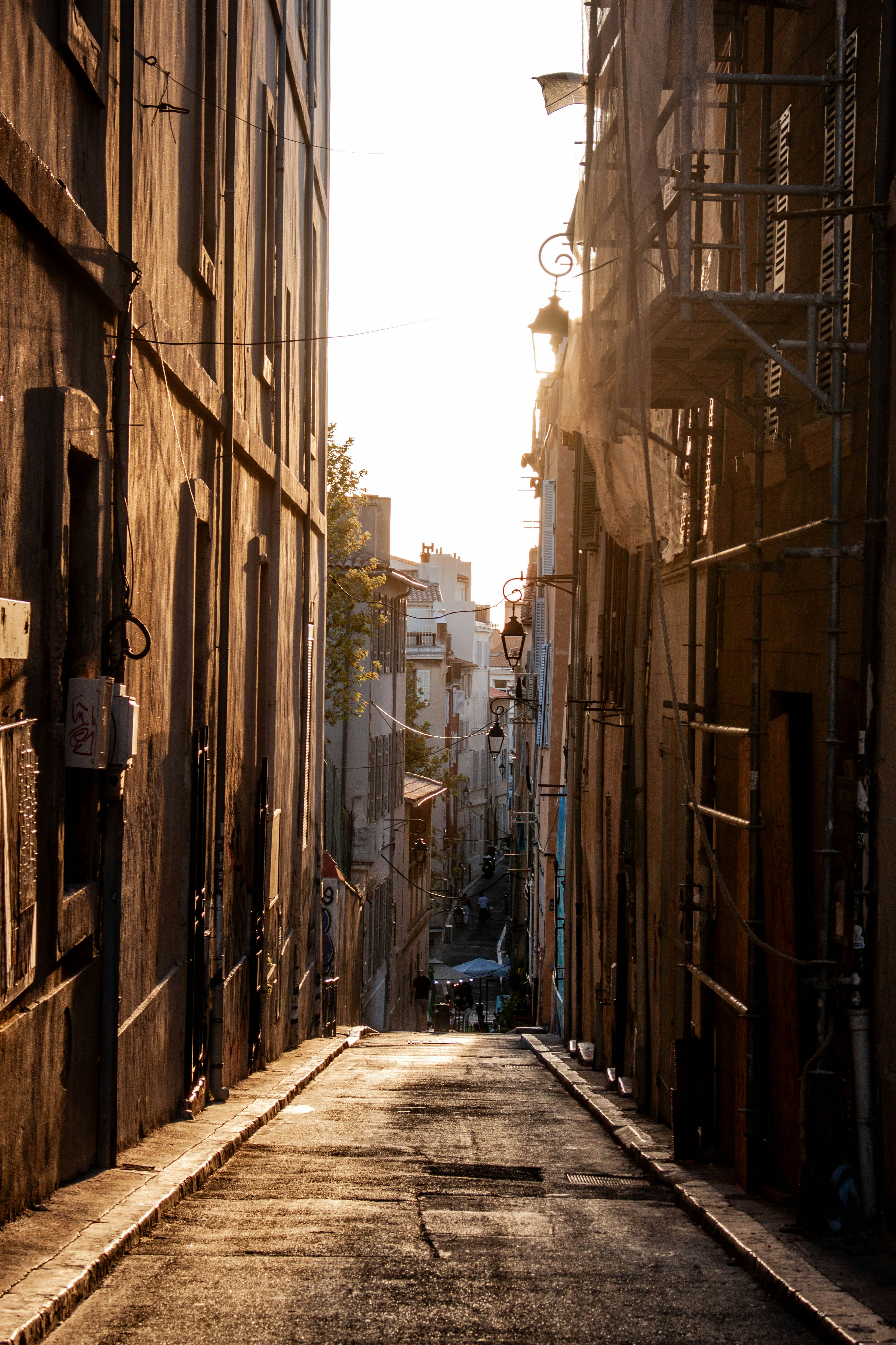 Sunlit Alleyway chute toward the distant square
