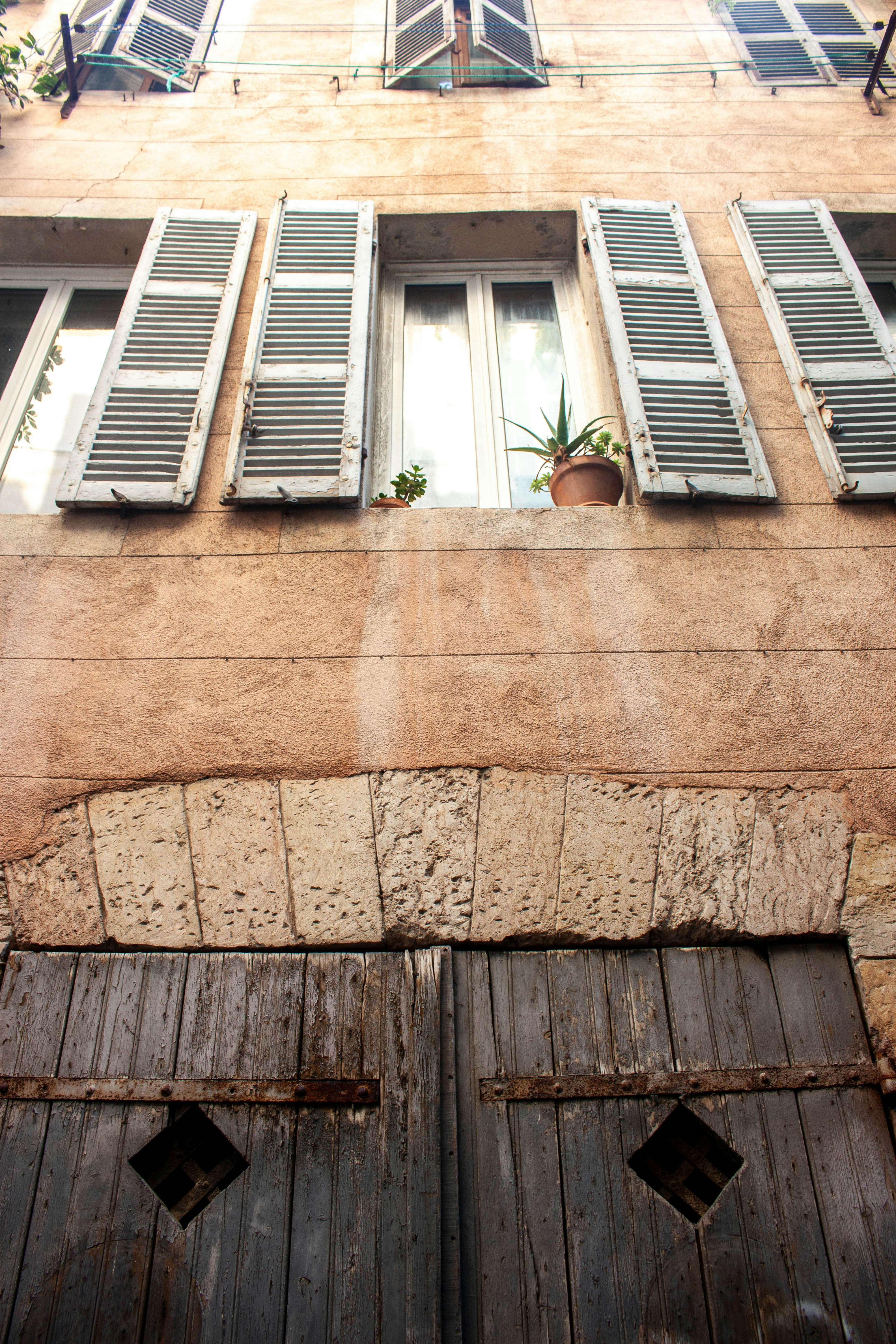 Old Stone Facade and Weathered Shutters