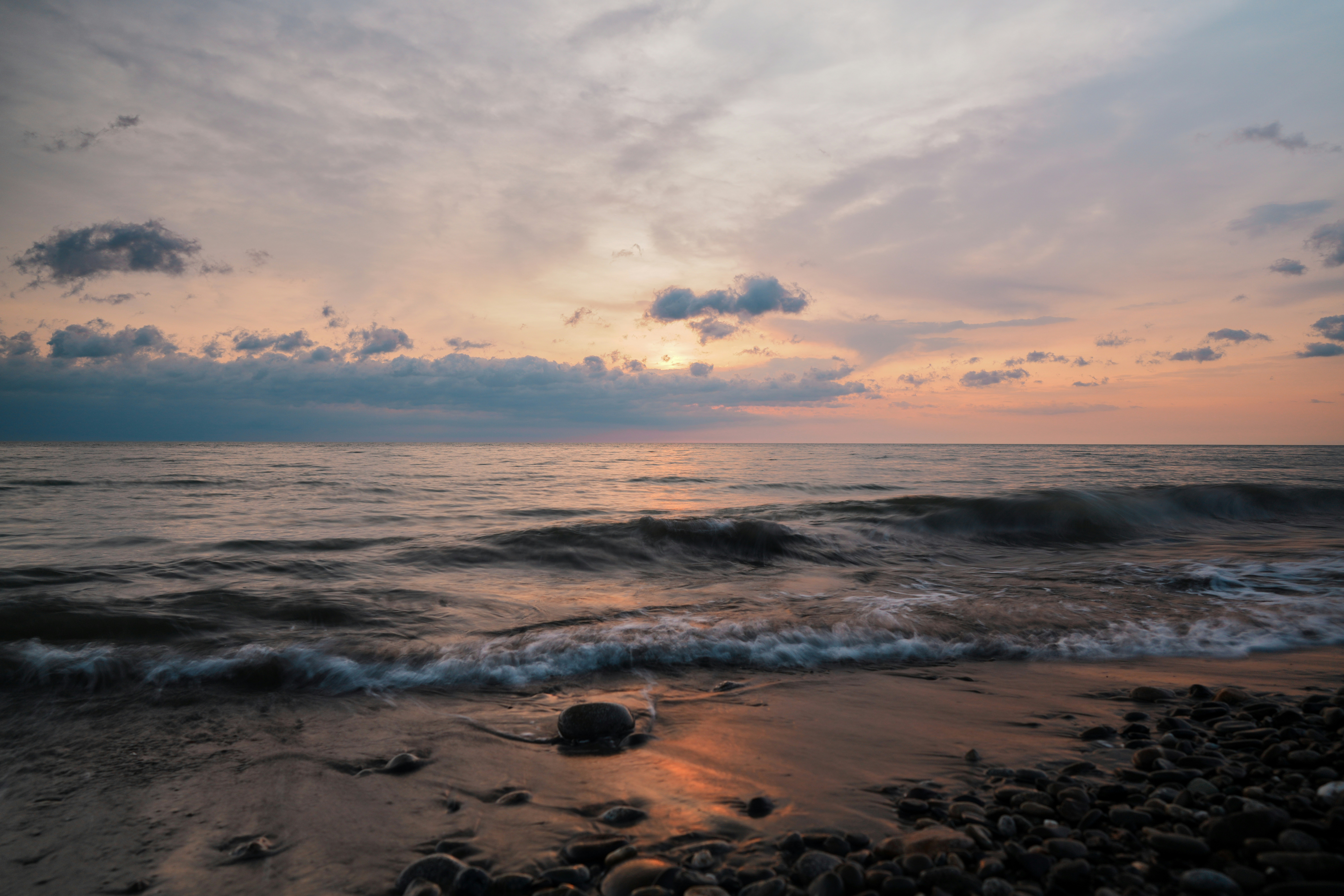 Sunset Quiet: Pebble Beach at the Edge of the Tide