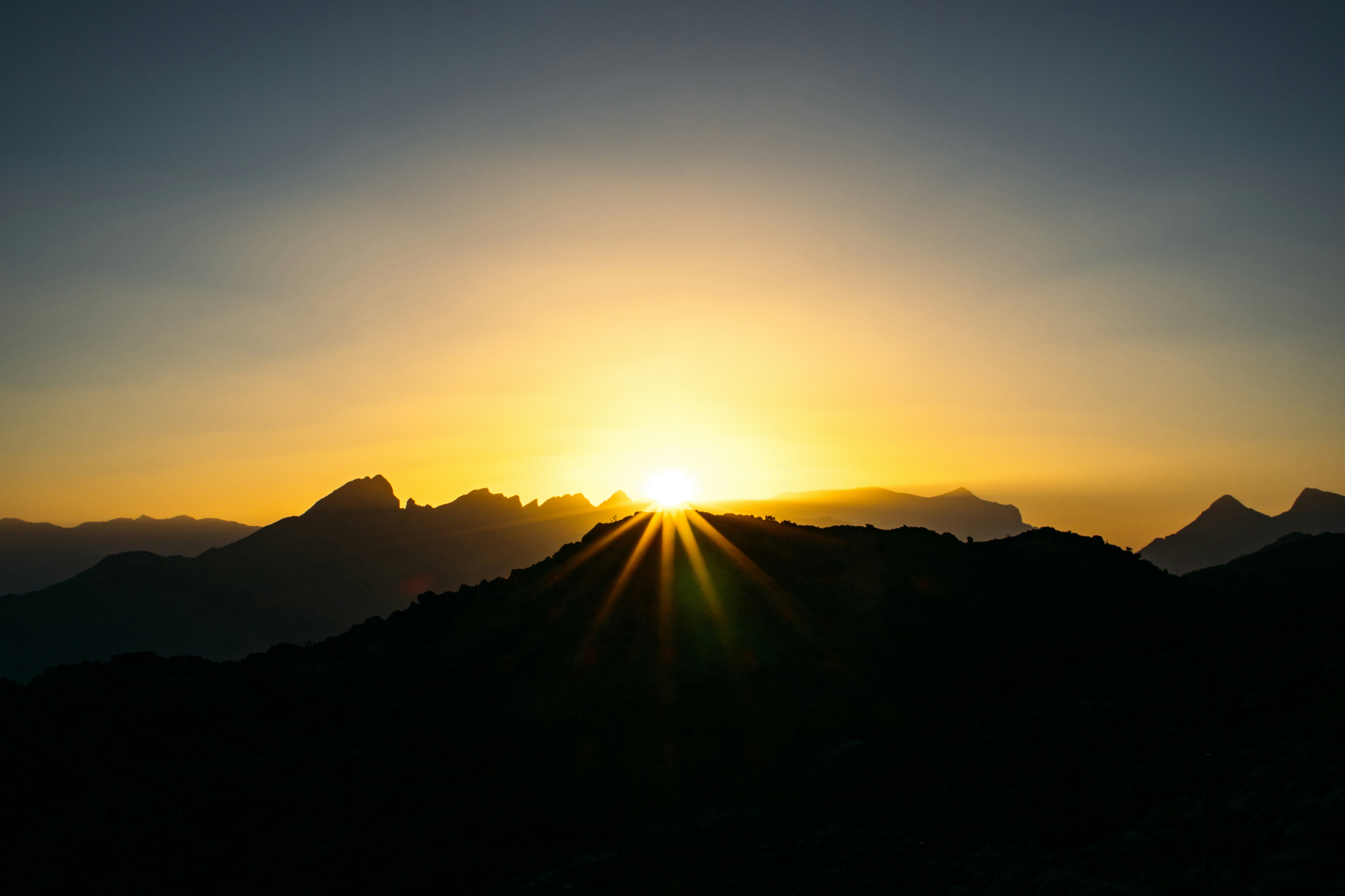 Edge of Light: Sunrise Over the Silhouetted Ridge