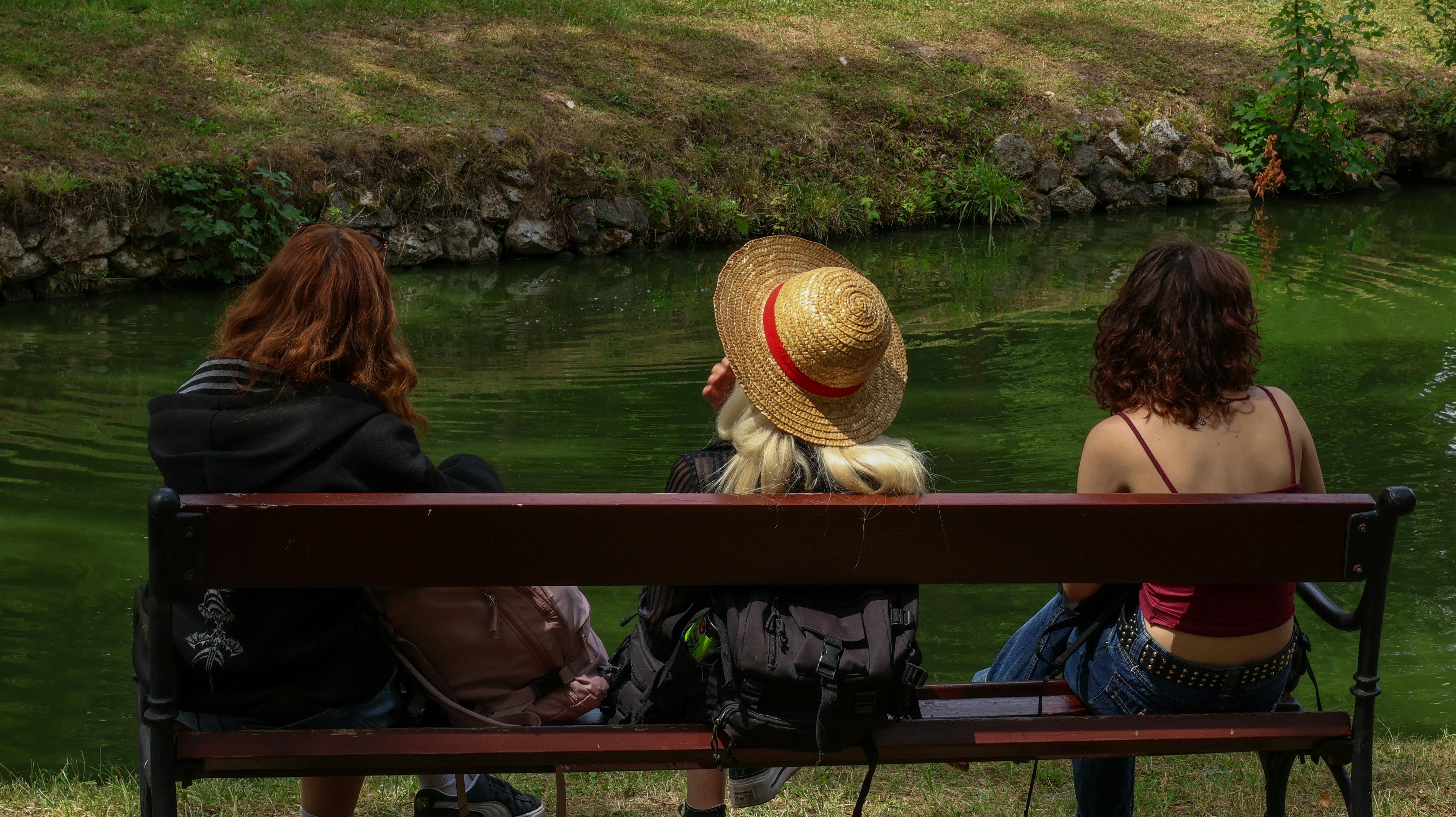 Three Friends on a Riverside Bench