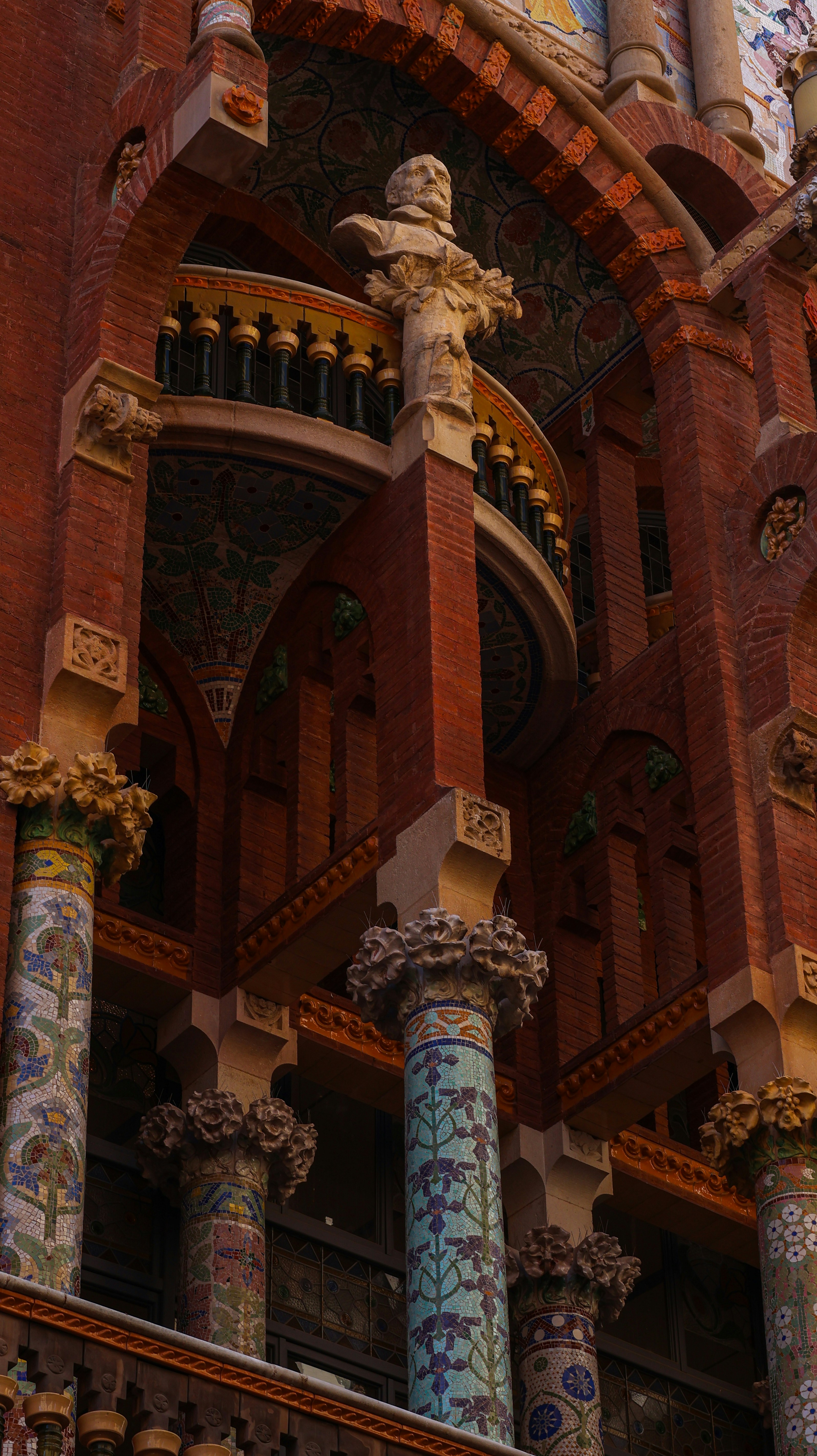 Architectural Mosaic: Mosaic Columns Rising Beneath a Stone Gargoyle