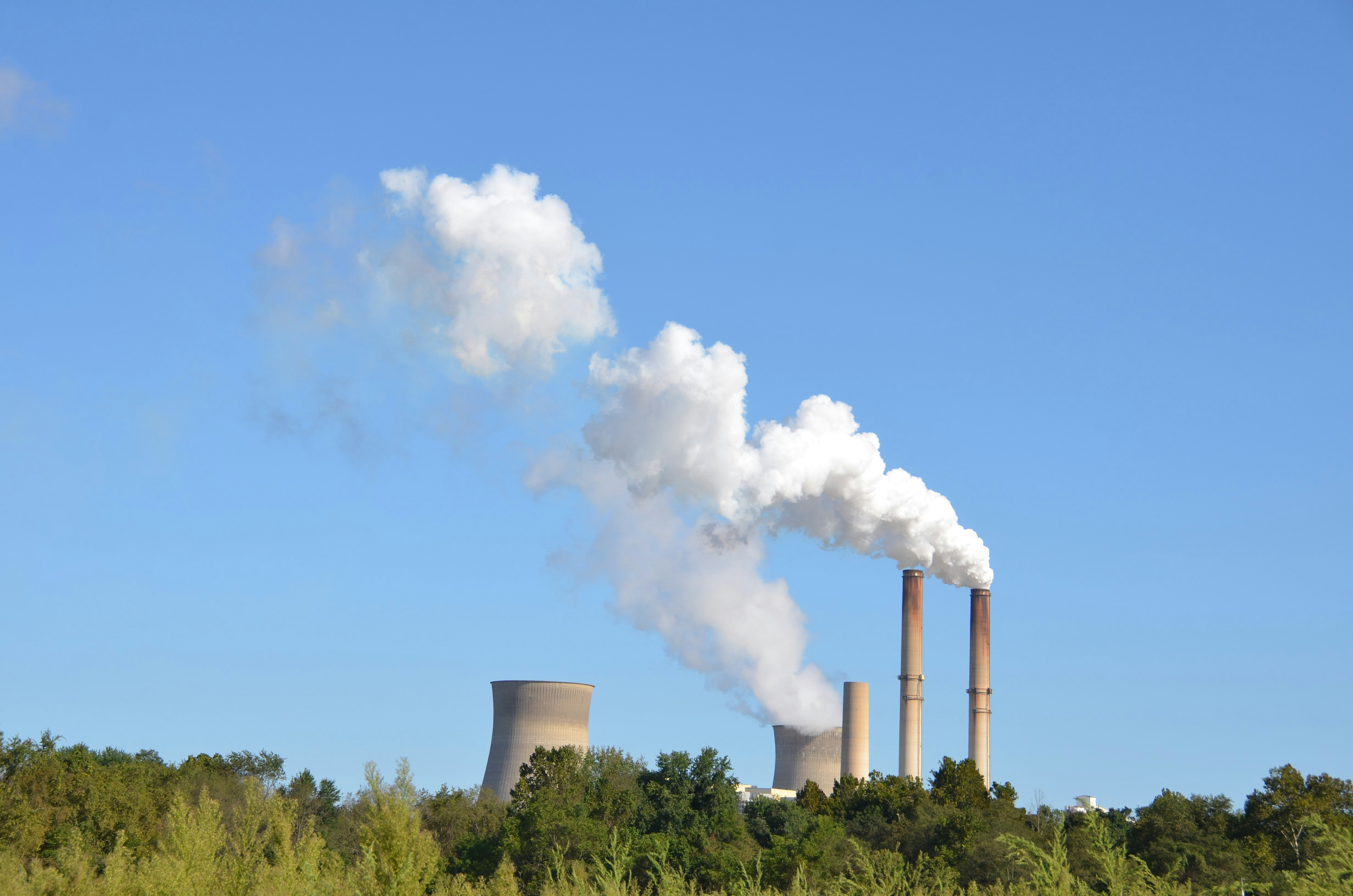 Industrial Skyline: Smoke Towers against a Quiet Horizon