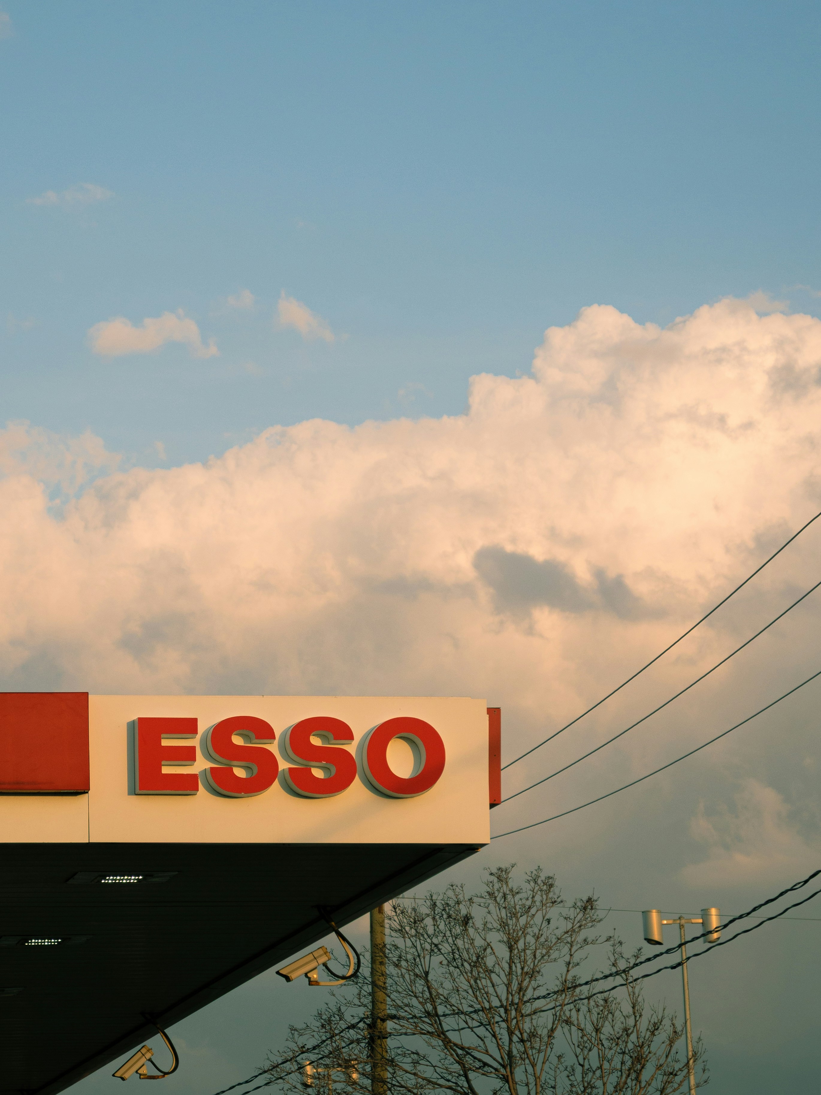 Esso Corner: Soft Clouds, Bold Red Letters
