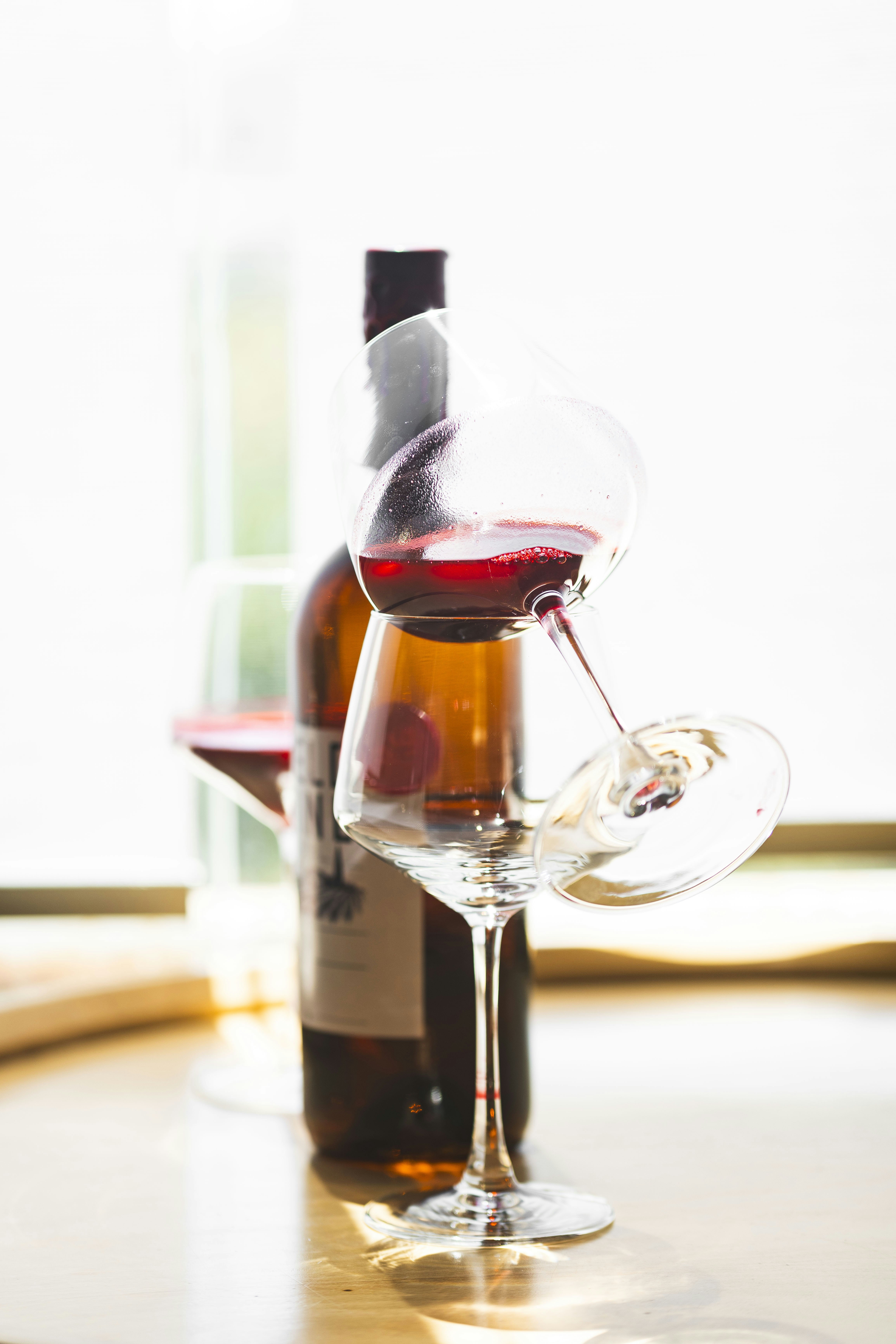 Wine Glasses and Bottle Backlit by Bright Window Light