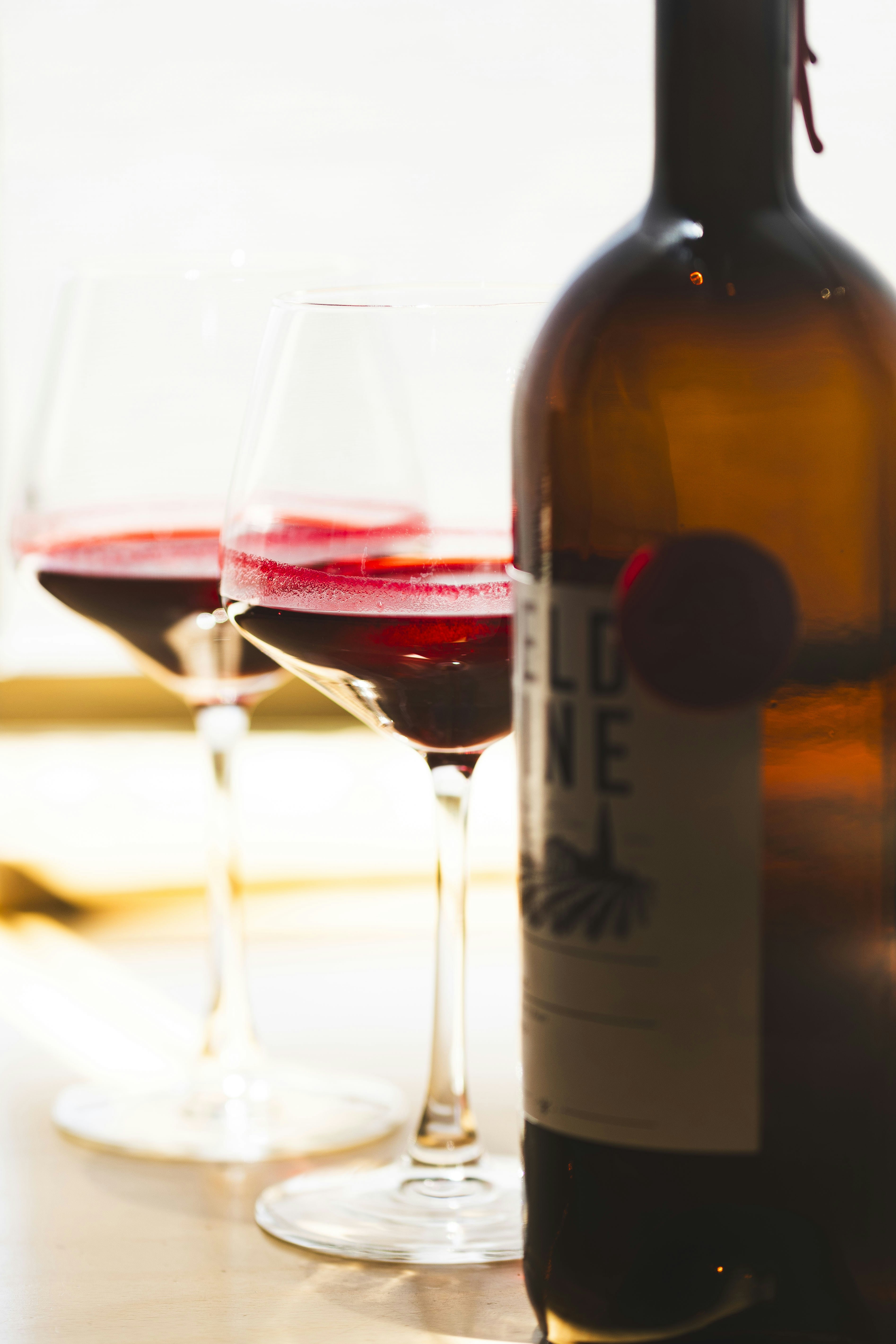 Crimson Toast: Focus on Glasses and Wine Bottle
