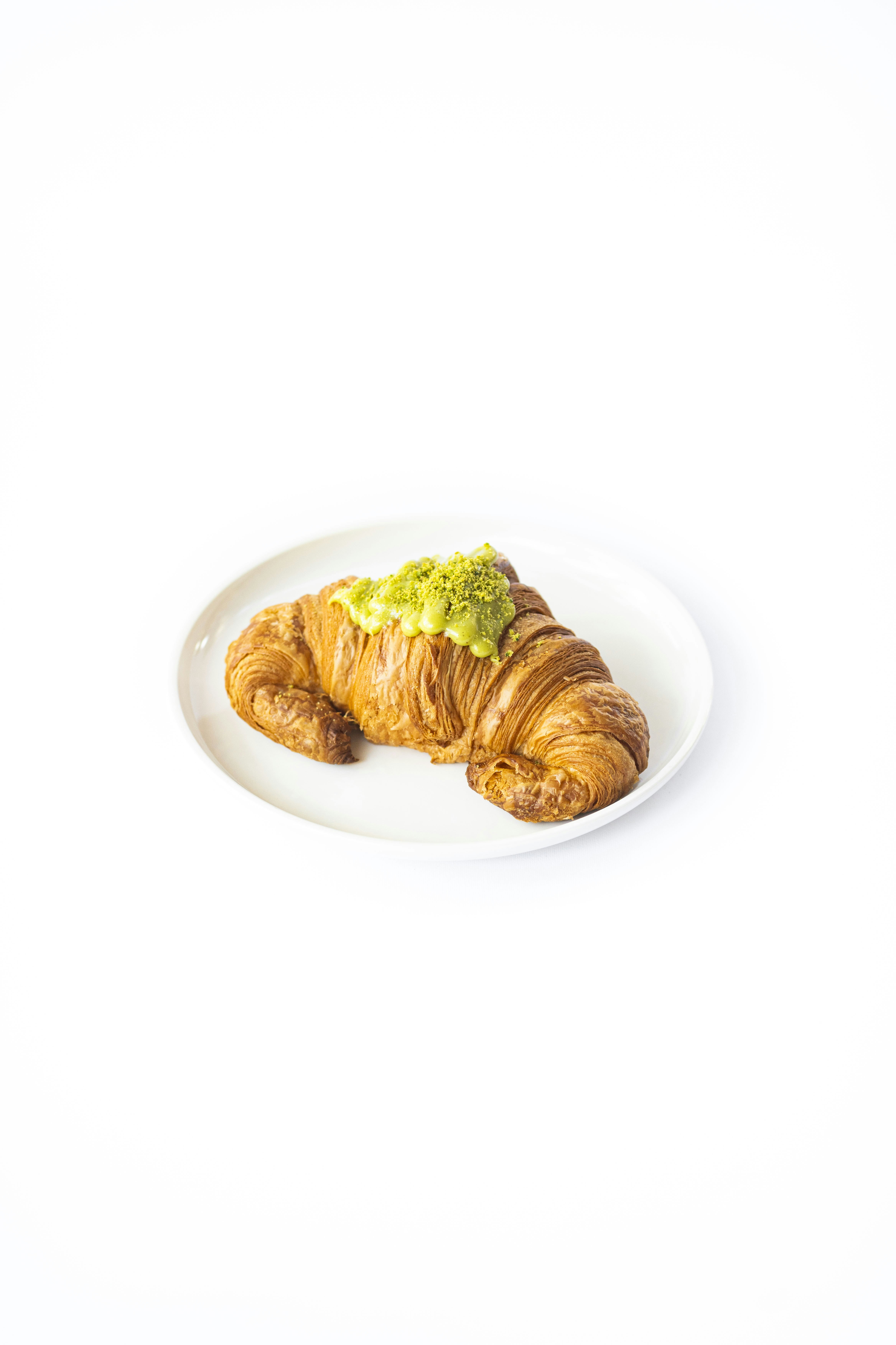 Golden Croissant on a White Plate: A Minimalist Dawn Snack