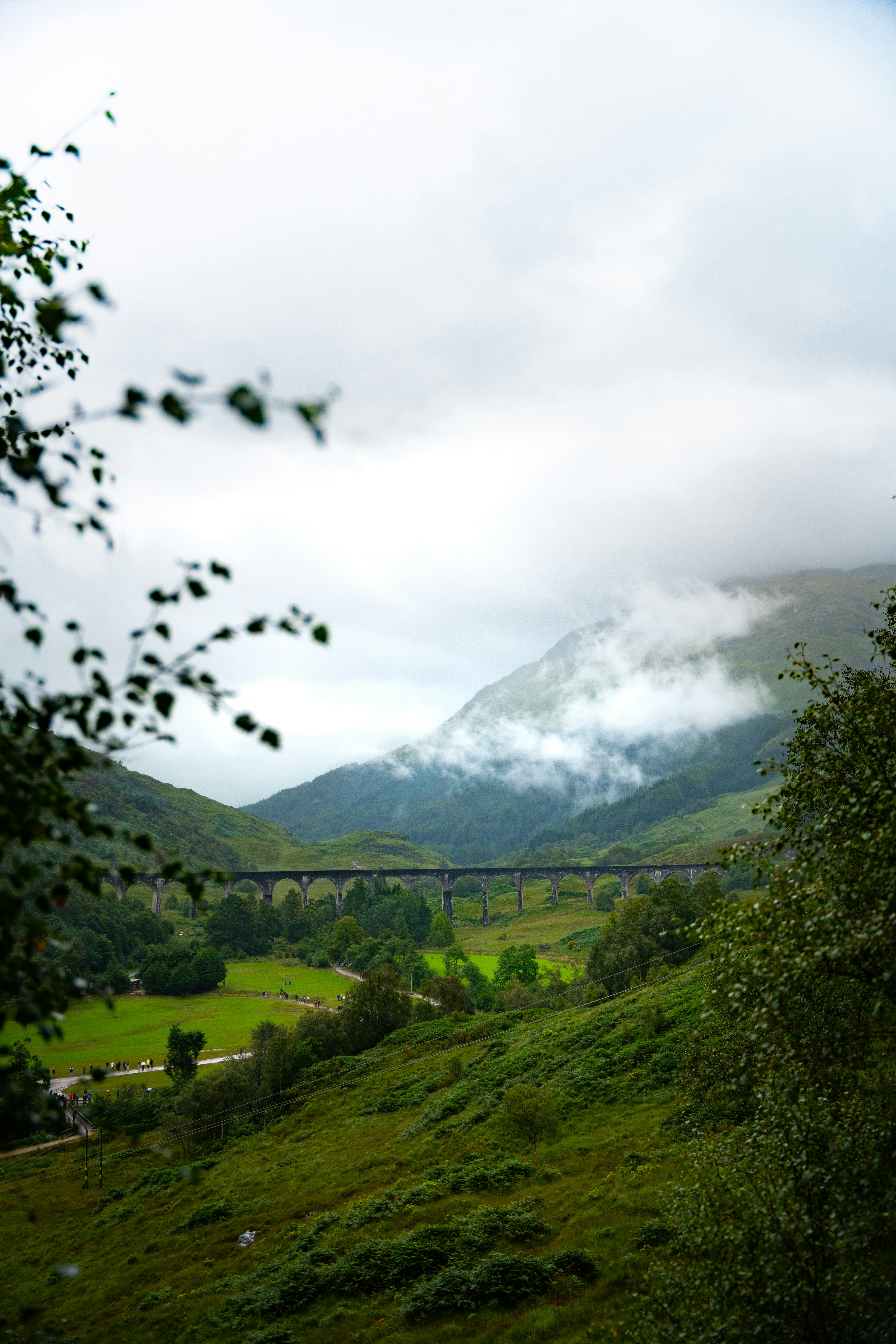 Mist over the viaduct: Green valley beneath a cloud-wreathed ridge