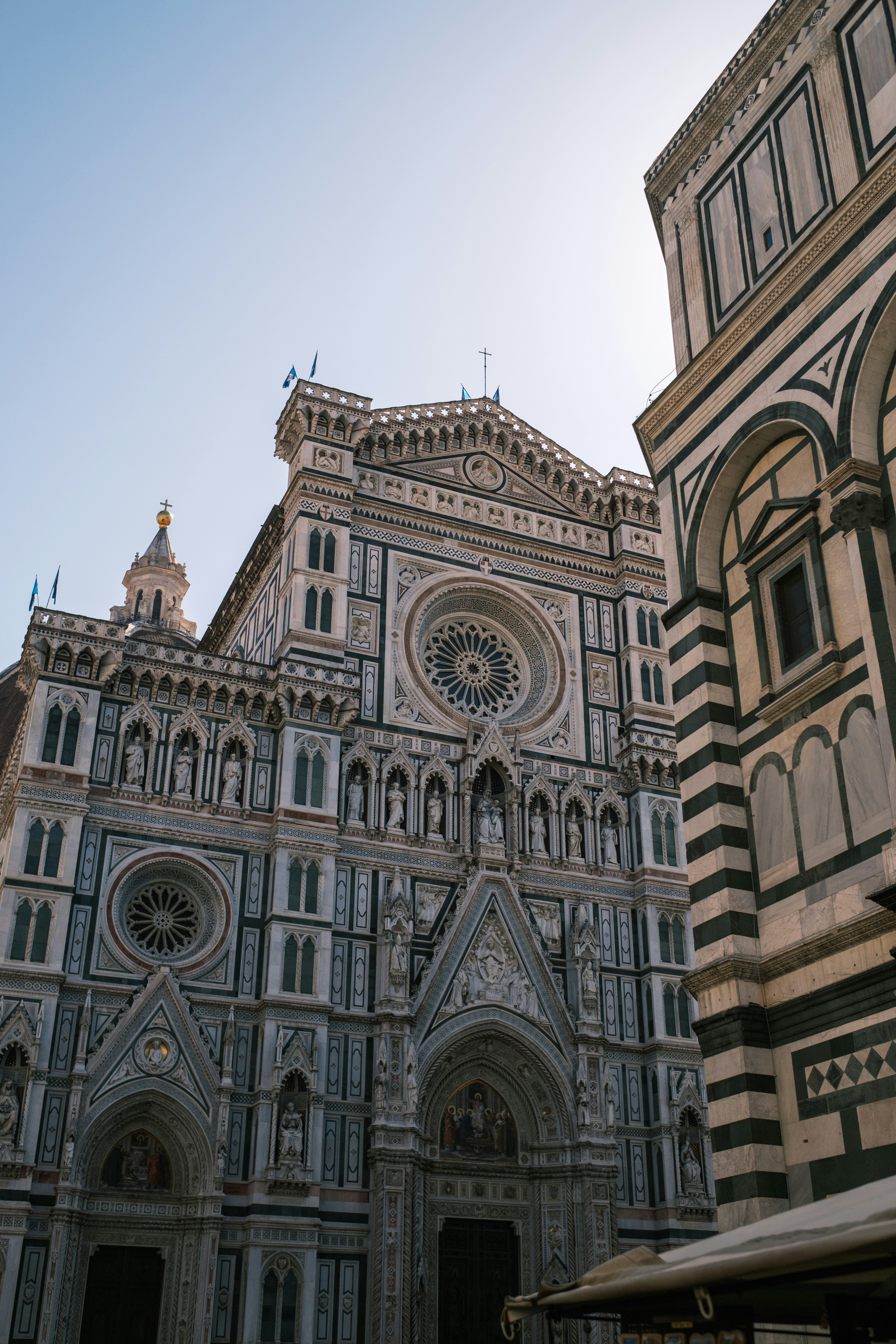 Facade of Florence Cathedral: intricate marble tracery under a clear sky