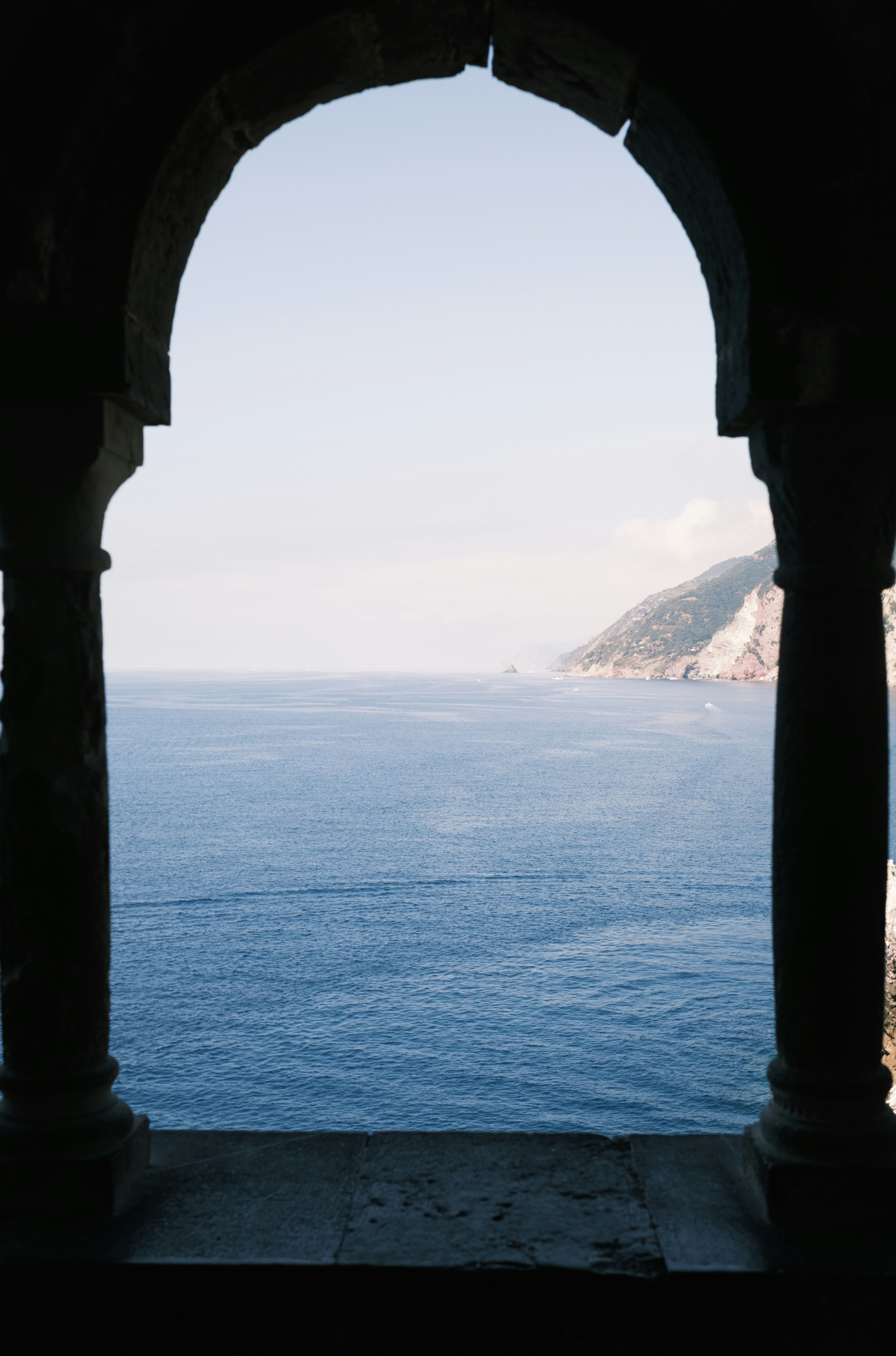 Sea View Through a Stone Archway at Dusk