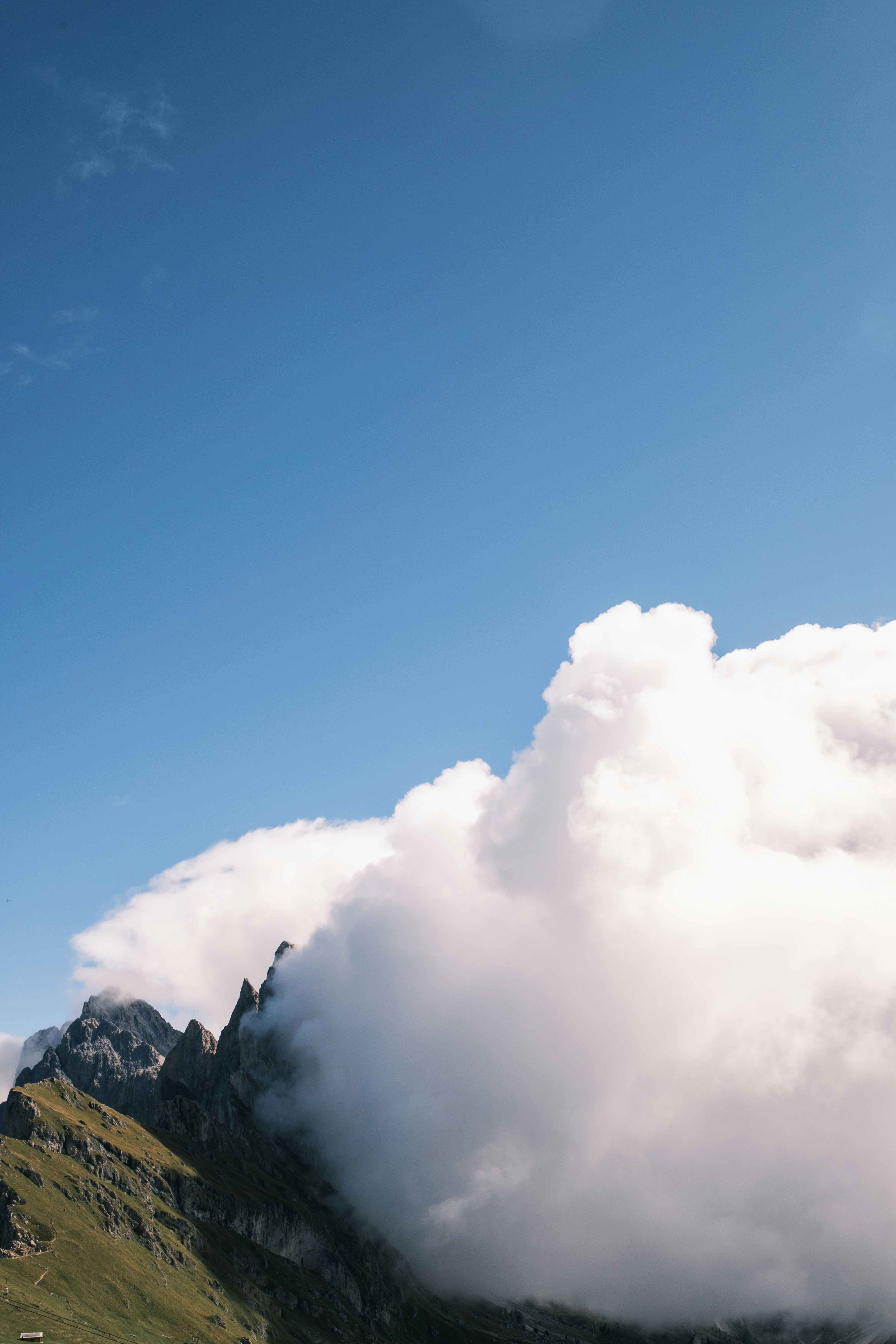 Cloudborne Peaks: A Sliver of Sky Above Alpine Crest