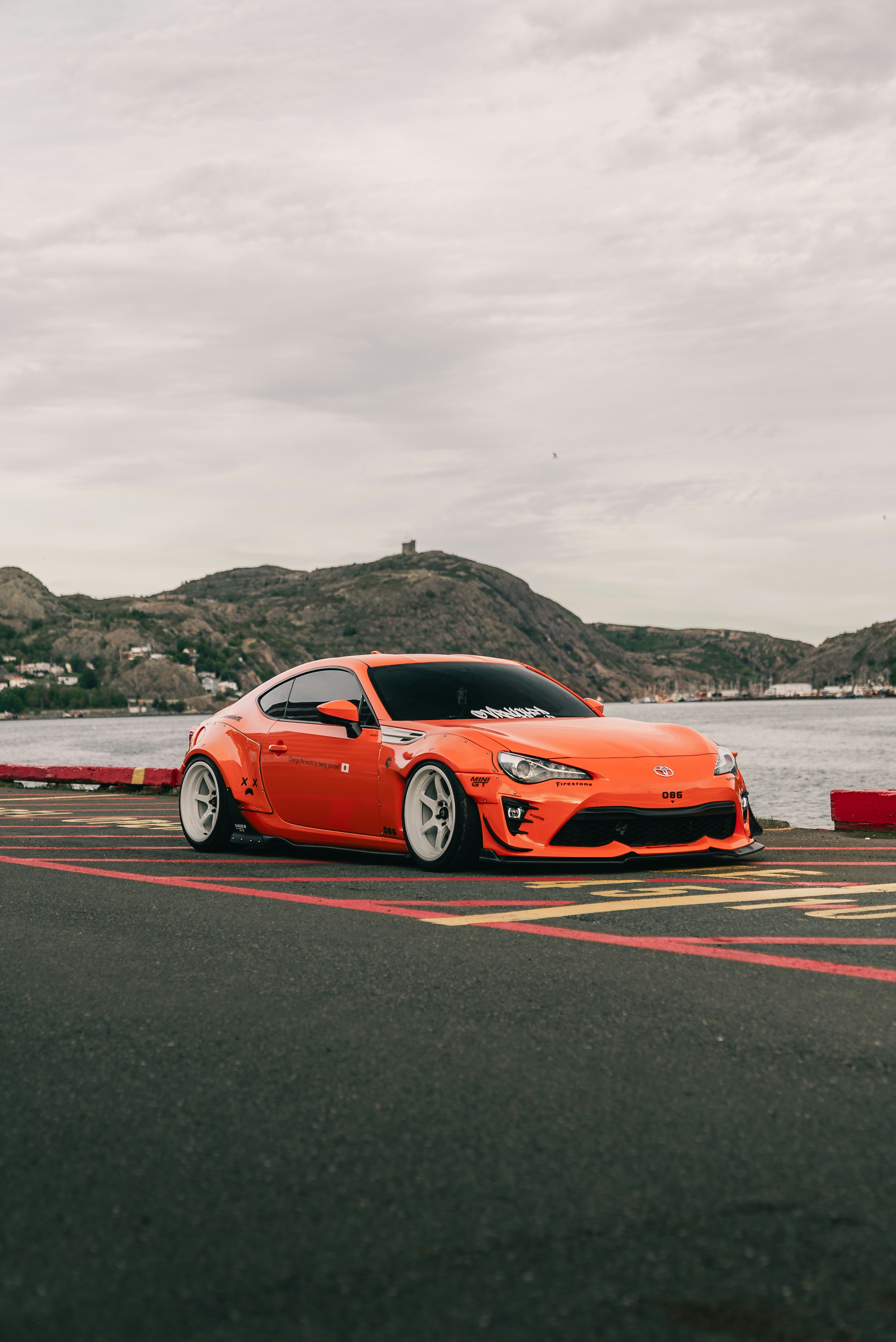 Red Apex: A Low-Tilt Arrival by the Waterfront