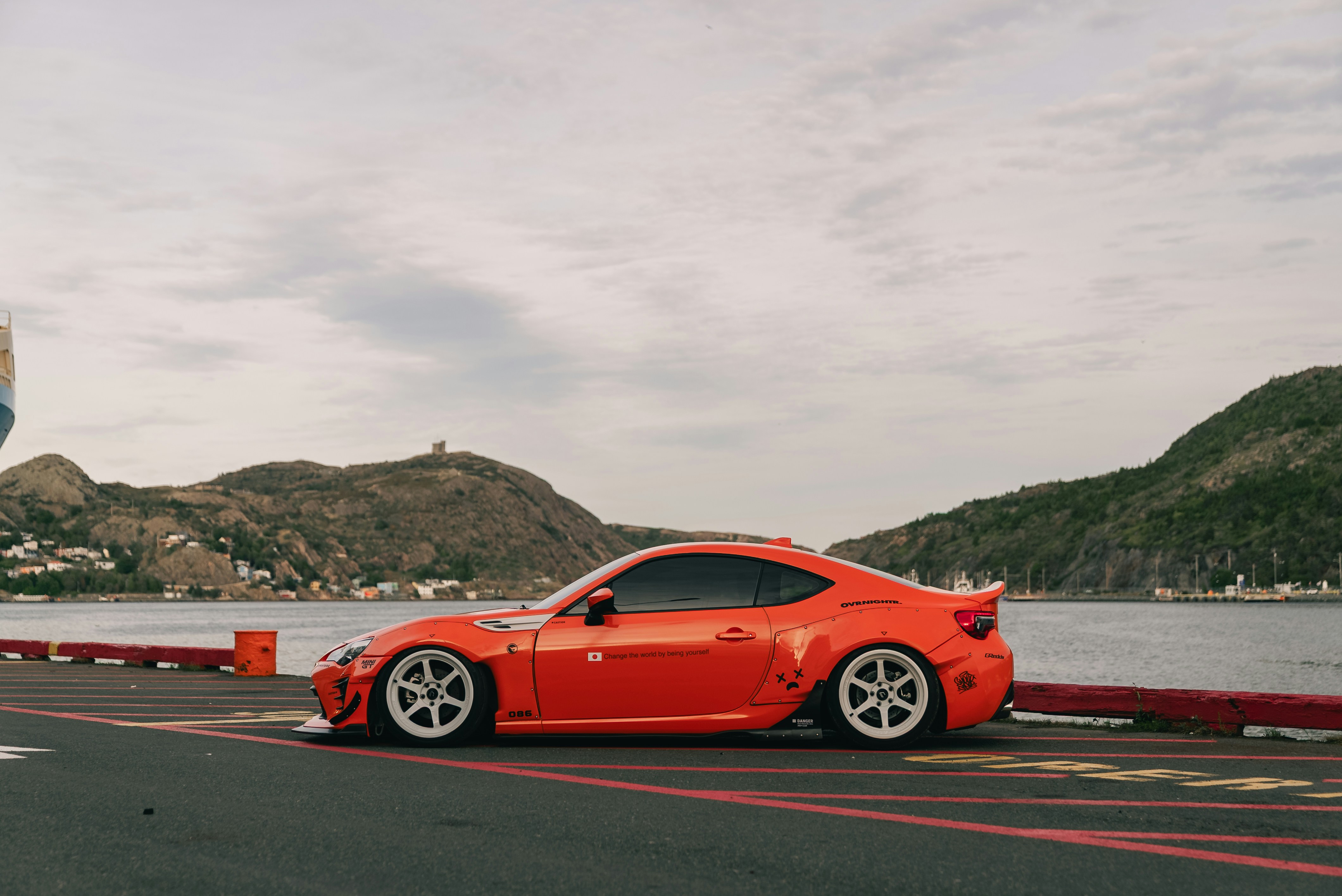 Red Racer by the Seaside: A Low-Angle Pause on the Pier