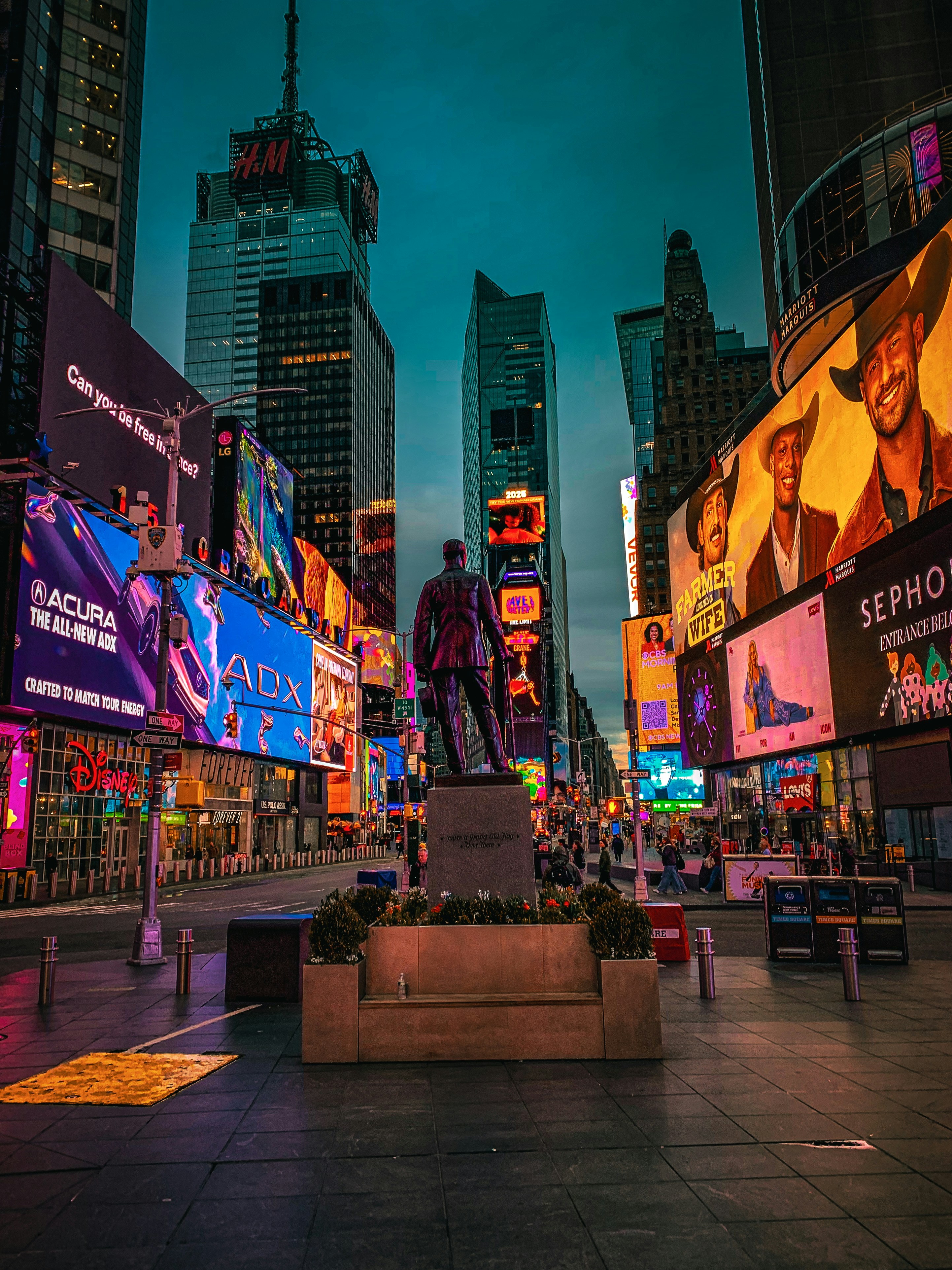 Statue Centerstage under Neon Skies: Times Square at Dusk