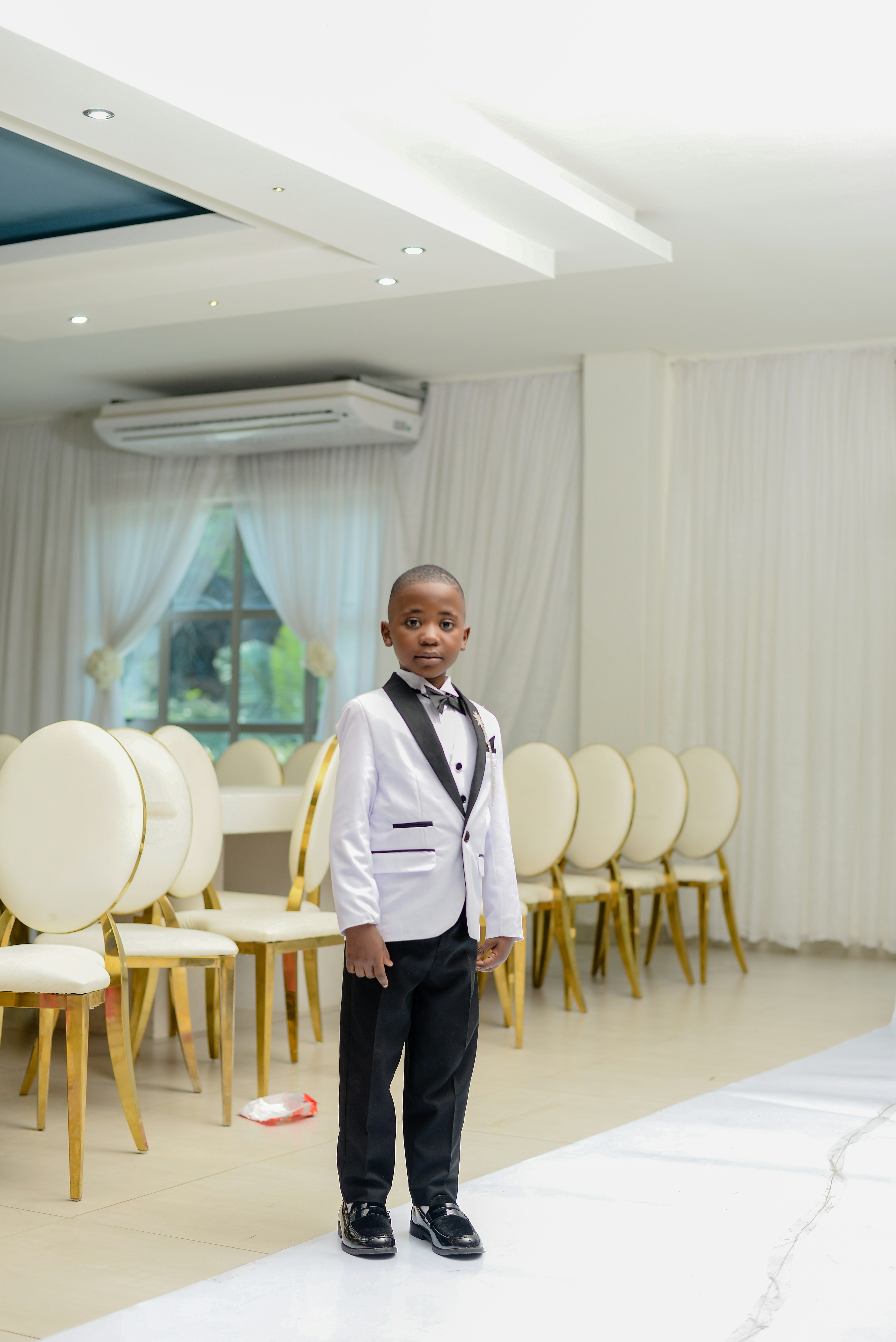 White-tie Moment: A Dapper Young Guest Stands Ready for the Big Day