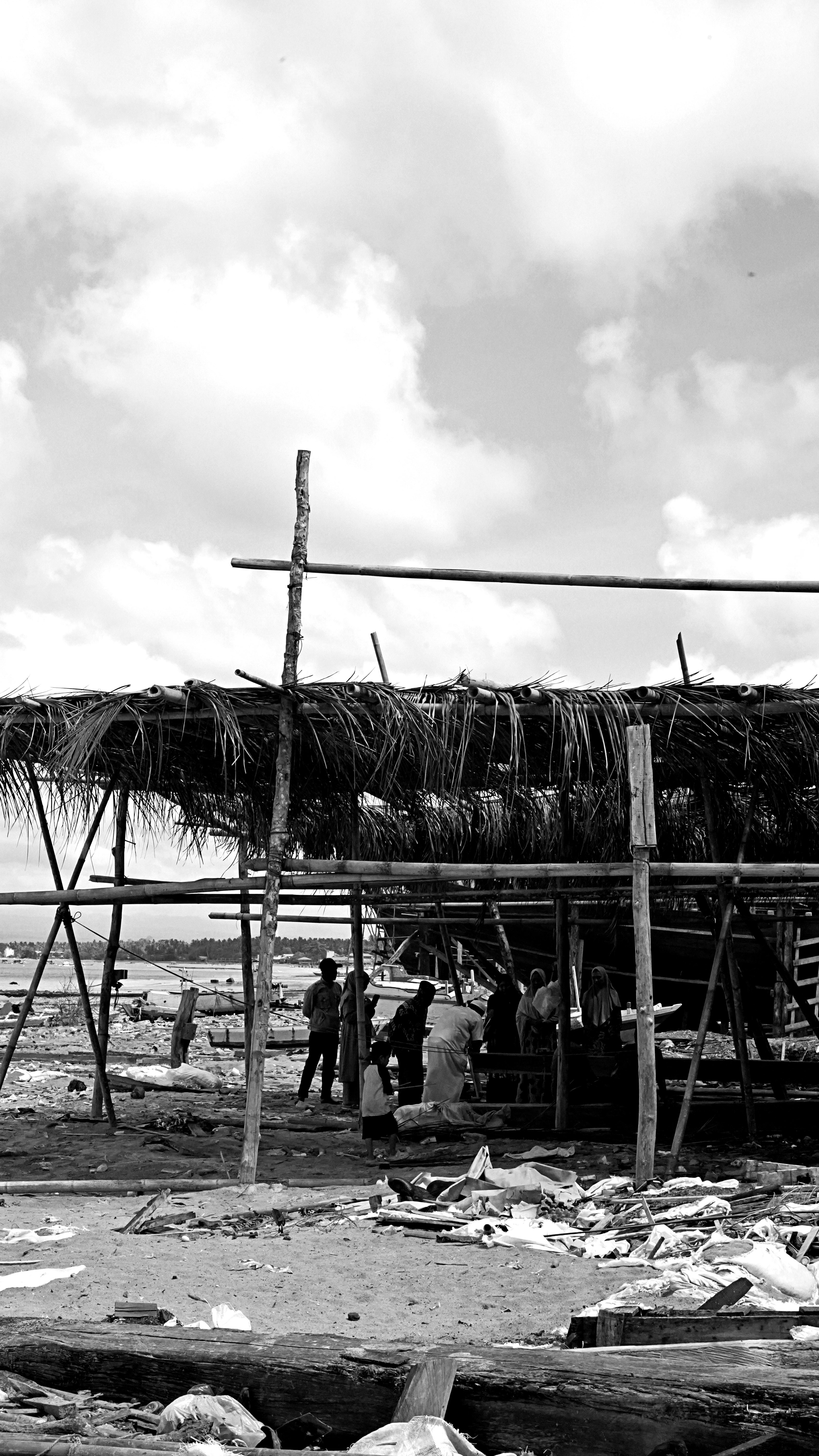 Shadowed Market Under a Reed-thatched Roof by the Shore