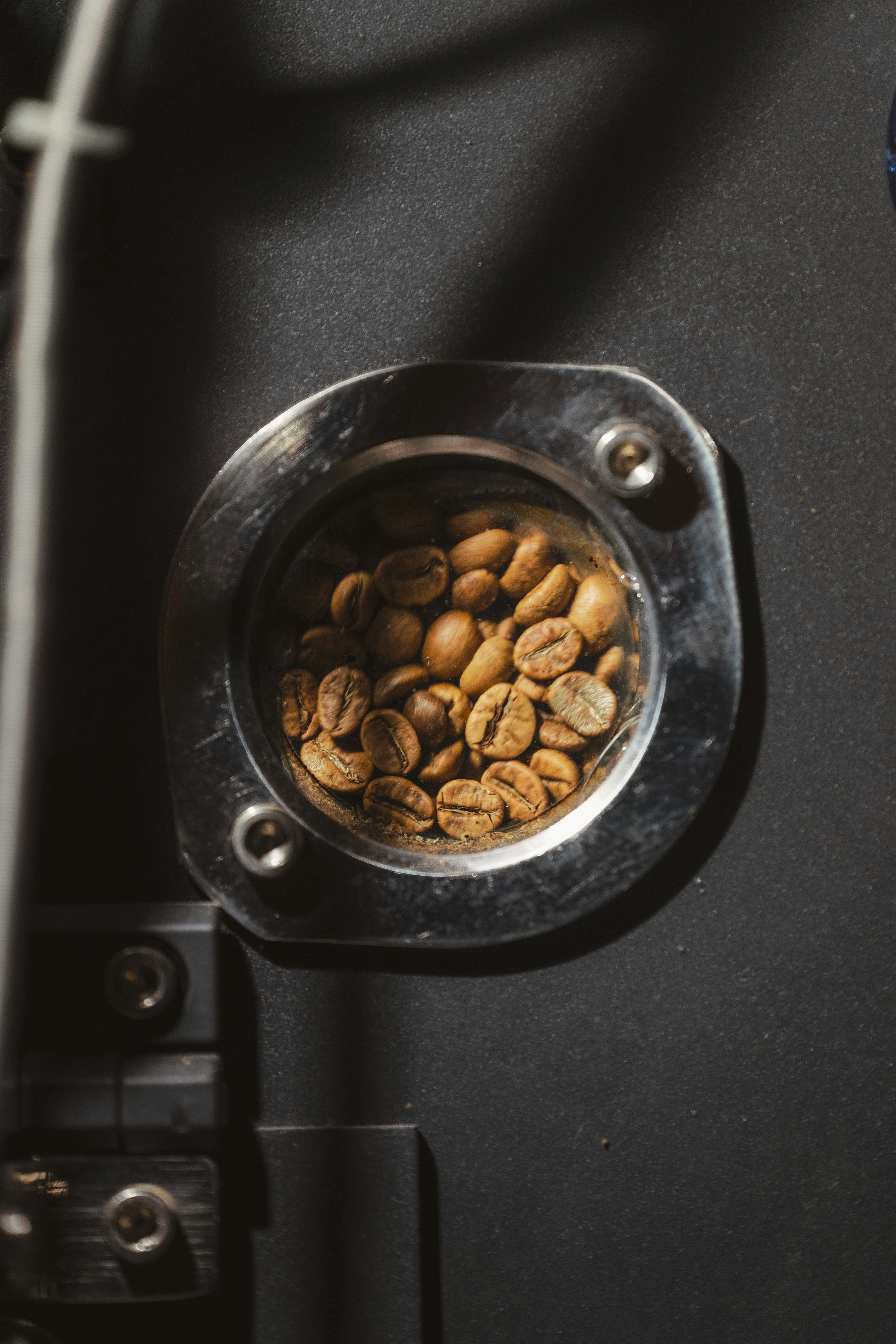 Orbital Roast: A Close-Up of Coffee Beans in a Portafilter Chamber