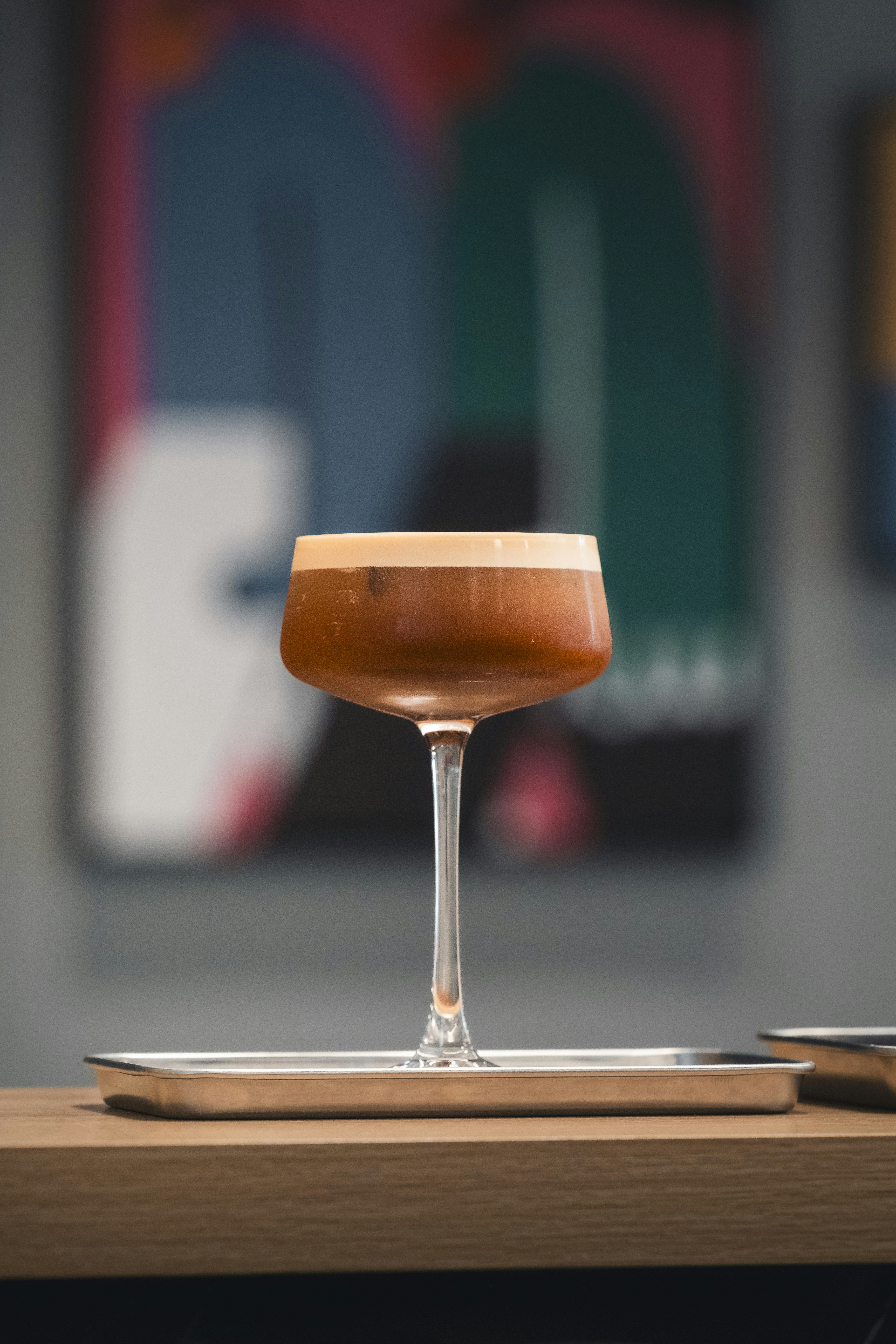 Glass of Espresso Sunset: A Central Sip Against Soft Gallery Blur