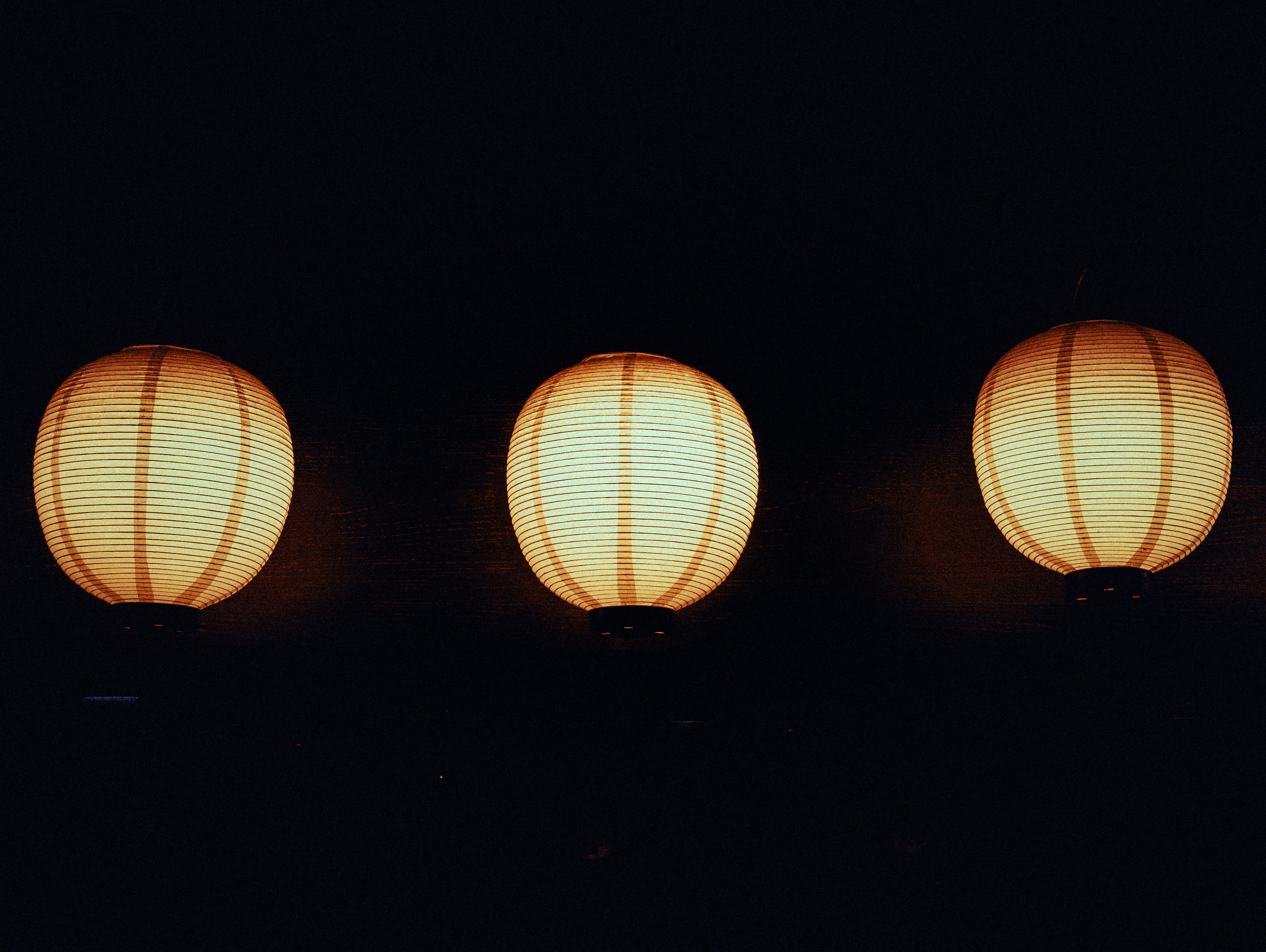 Triple Lanterns: Night-lit Orbs in a Velvet Void