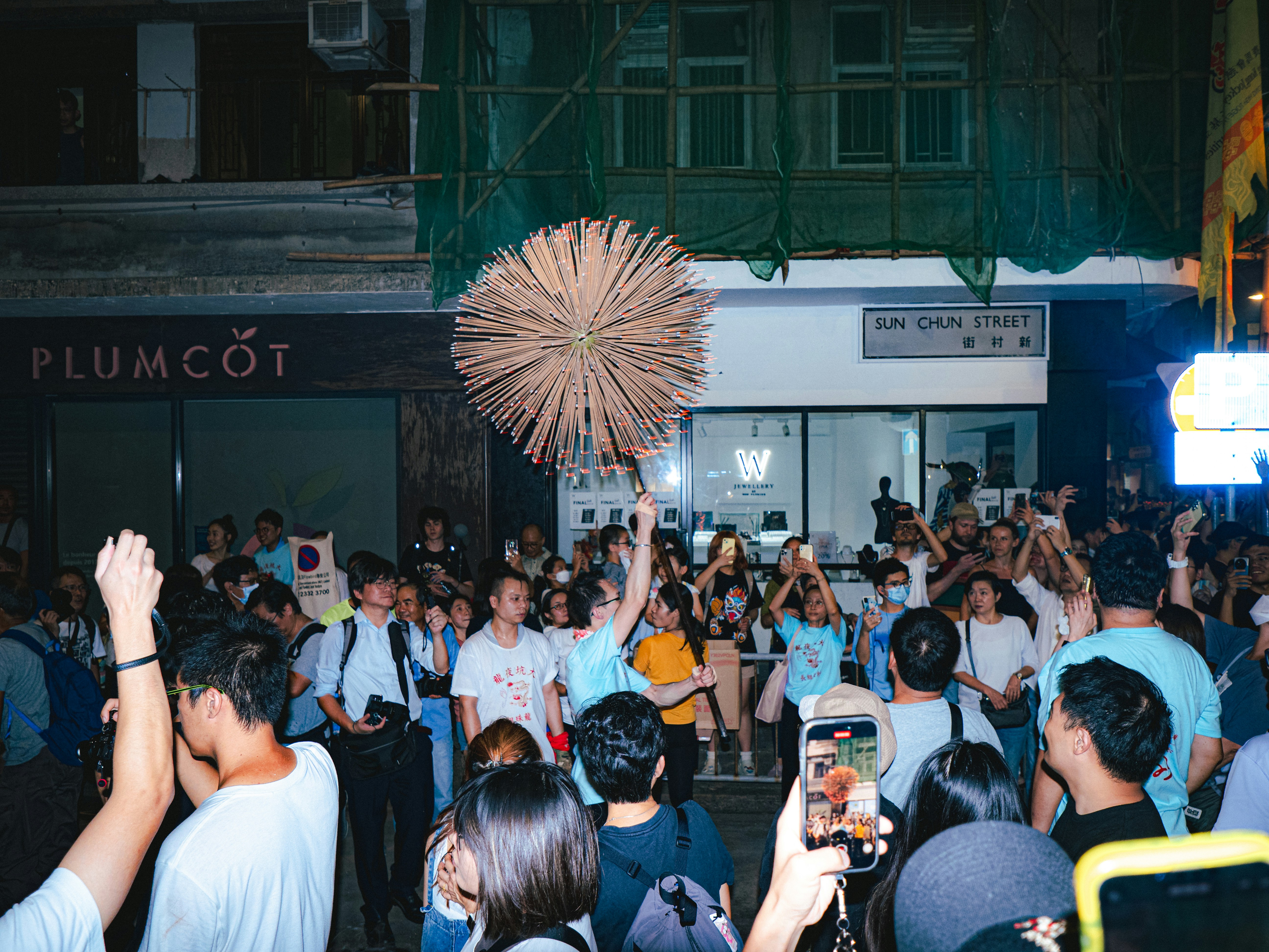 Dawn of the Firework Crowd: A Night Market Celebration