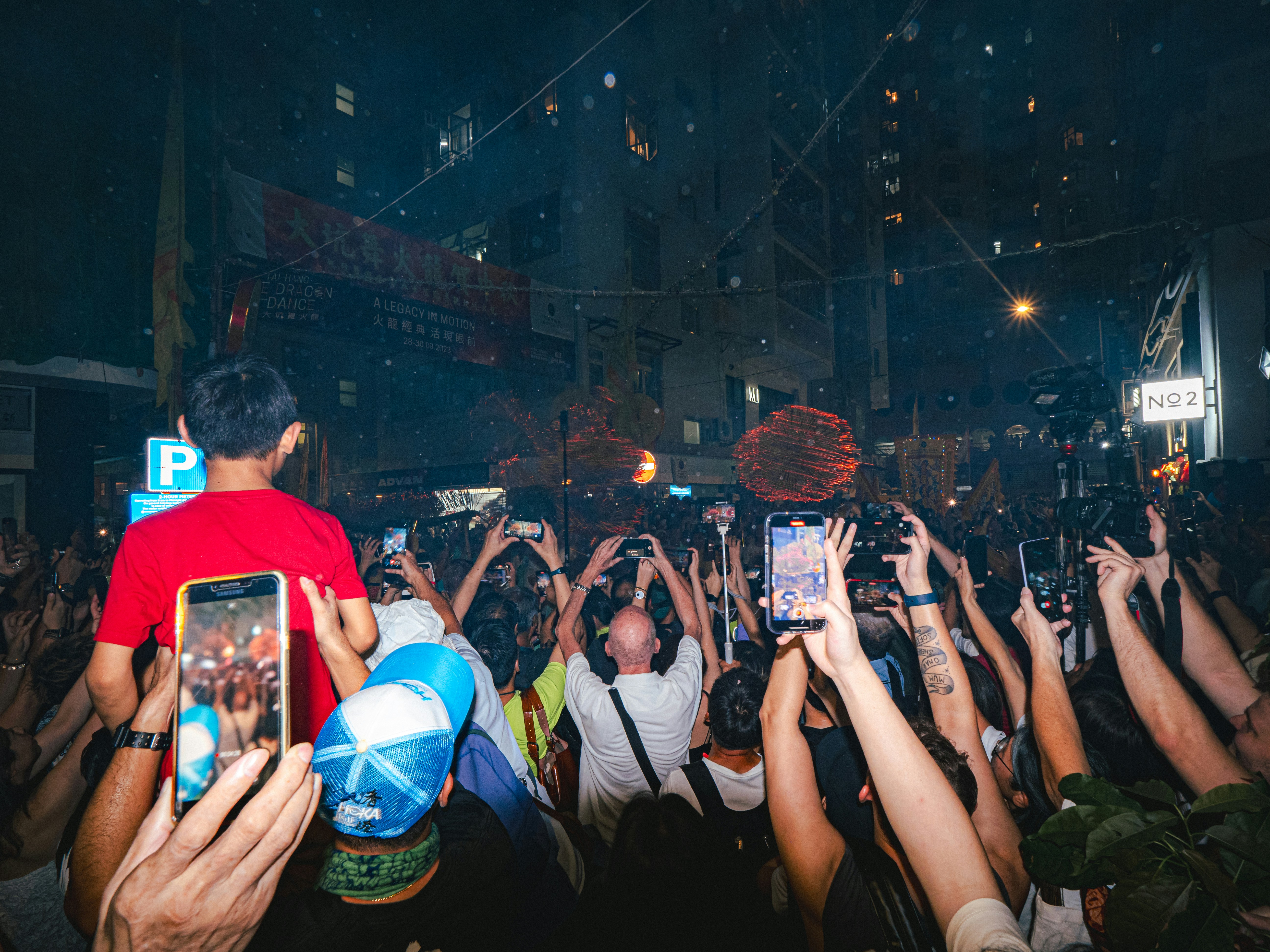Night Street Pulse: Hands Raise the City in Red