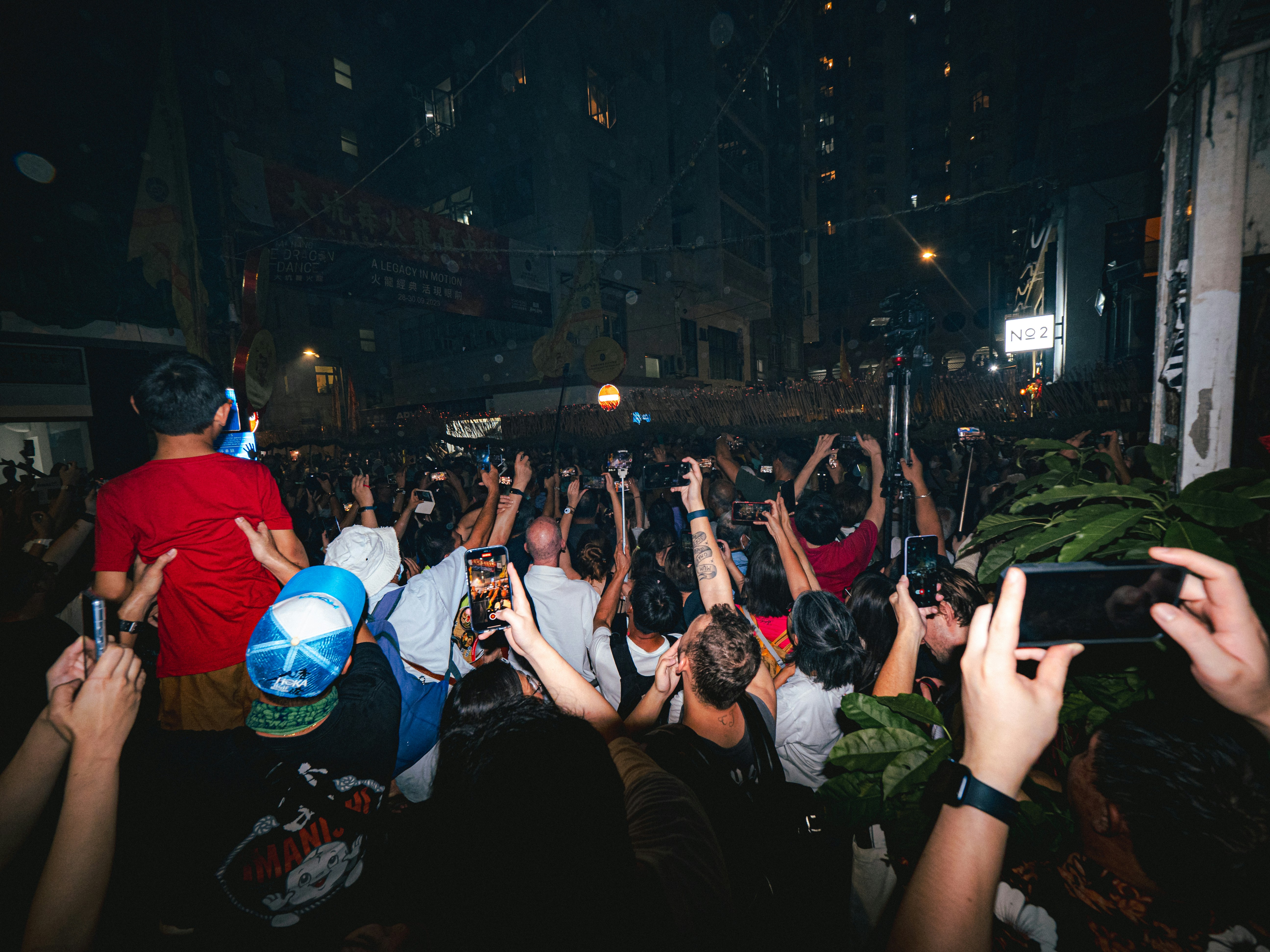 Midnight Melting Pot: A Sea of Phones and Faces in the City Pulse