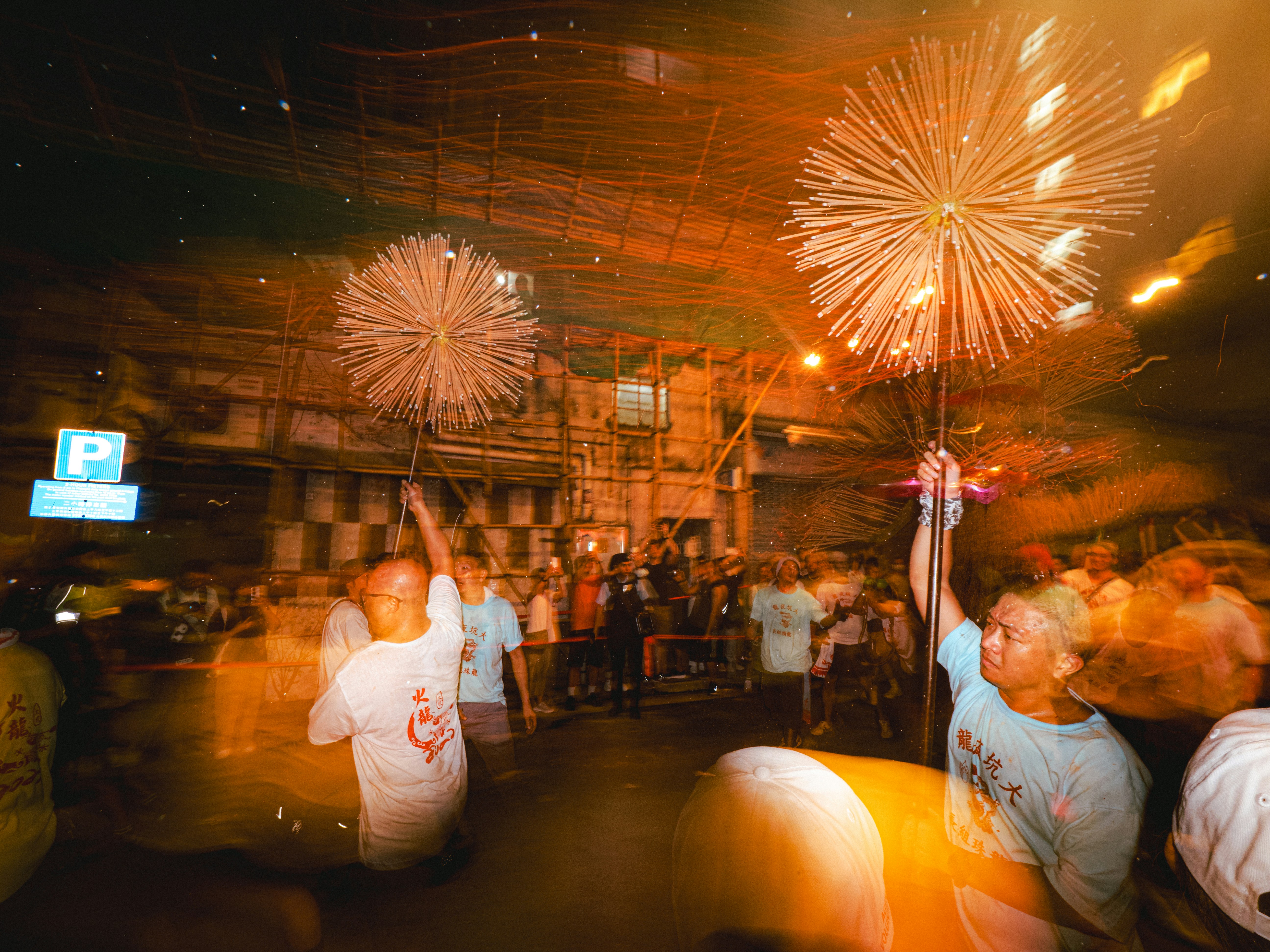 Fireworks in Motion: Nighttime Street Celebration with Blurred Crowd