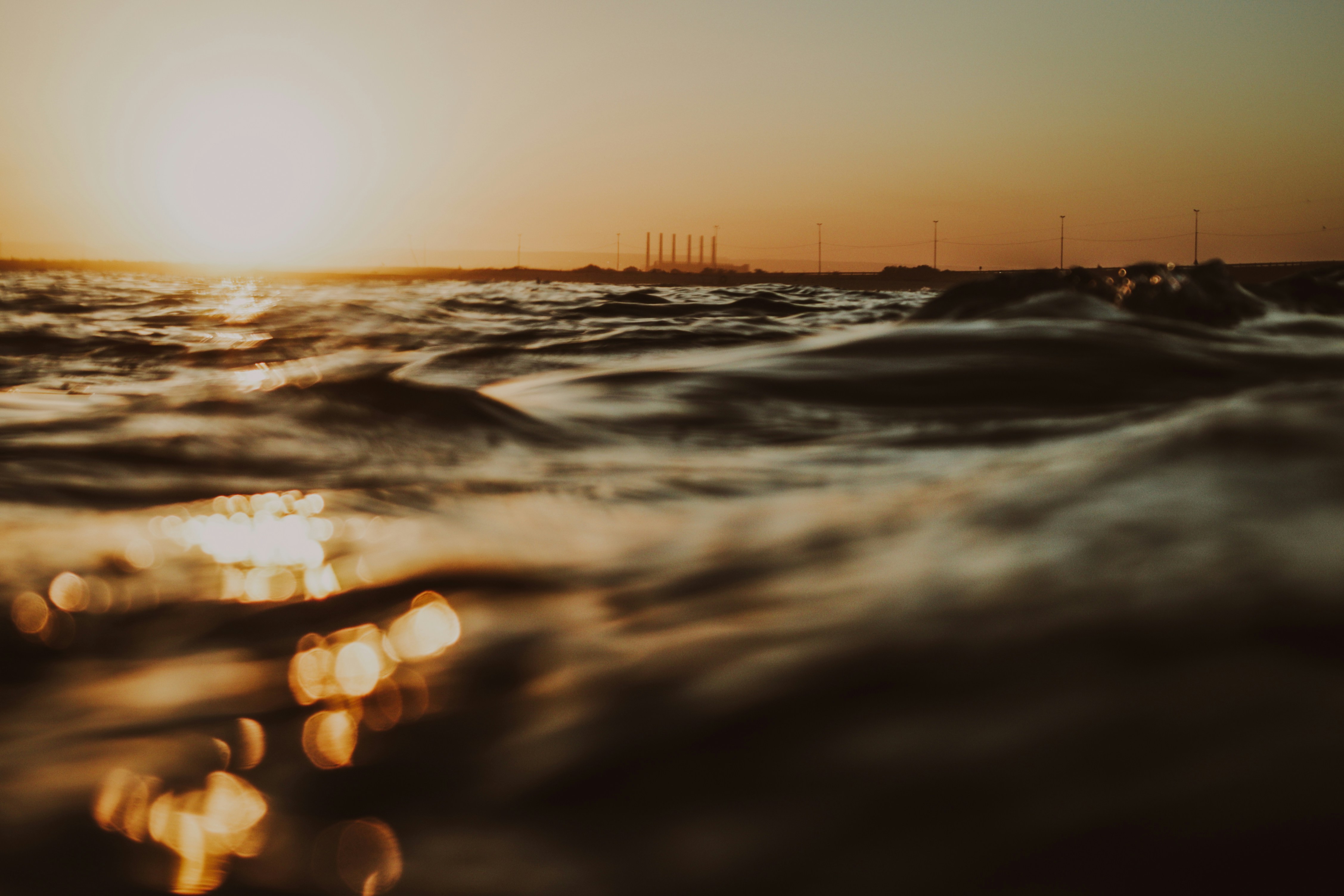 Low Tide Horizon: Sunlit Ripples and Silhouettes at Dusk
