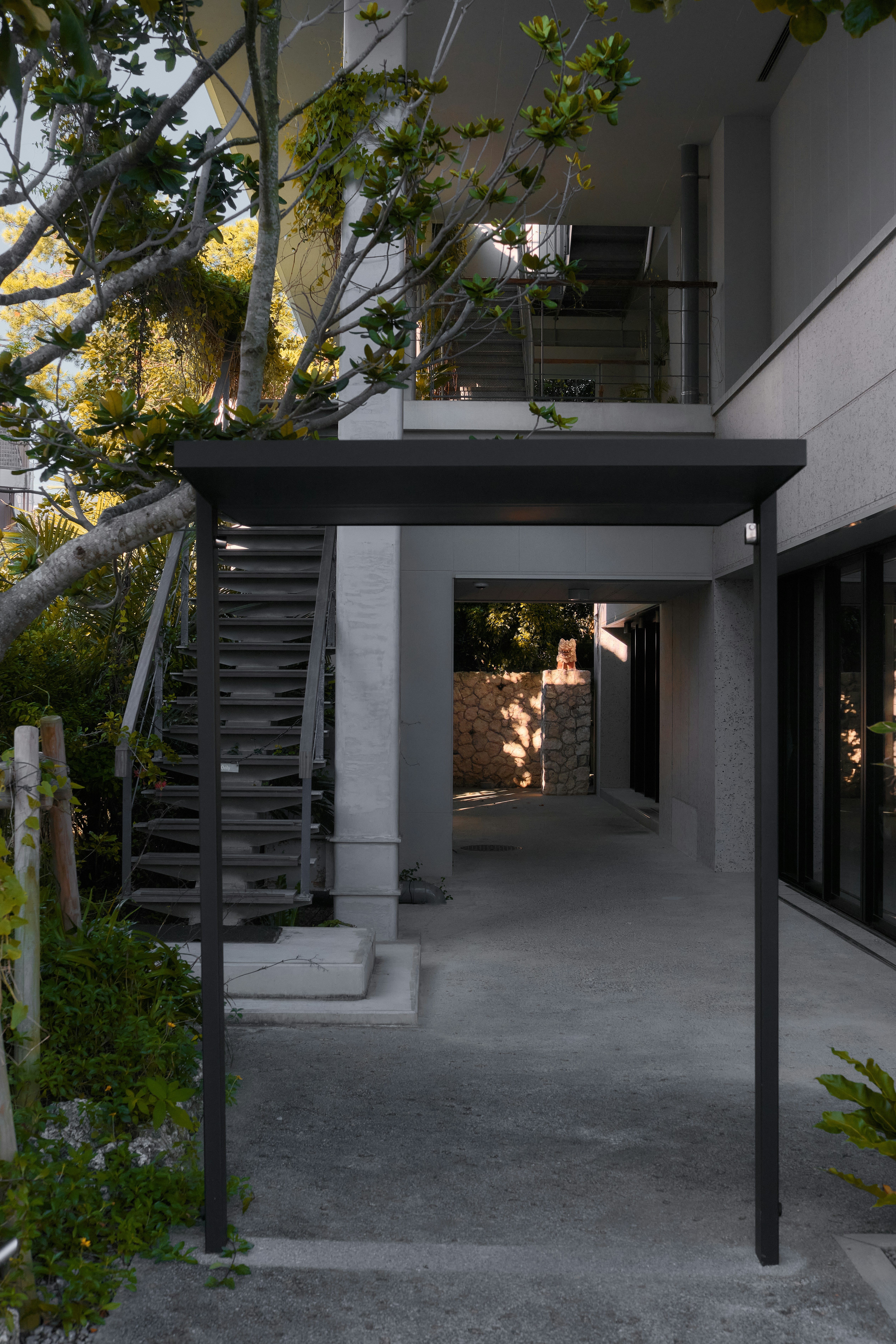 Concrete Corridor Under a Shaded Archway