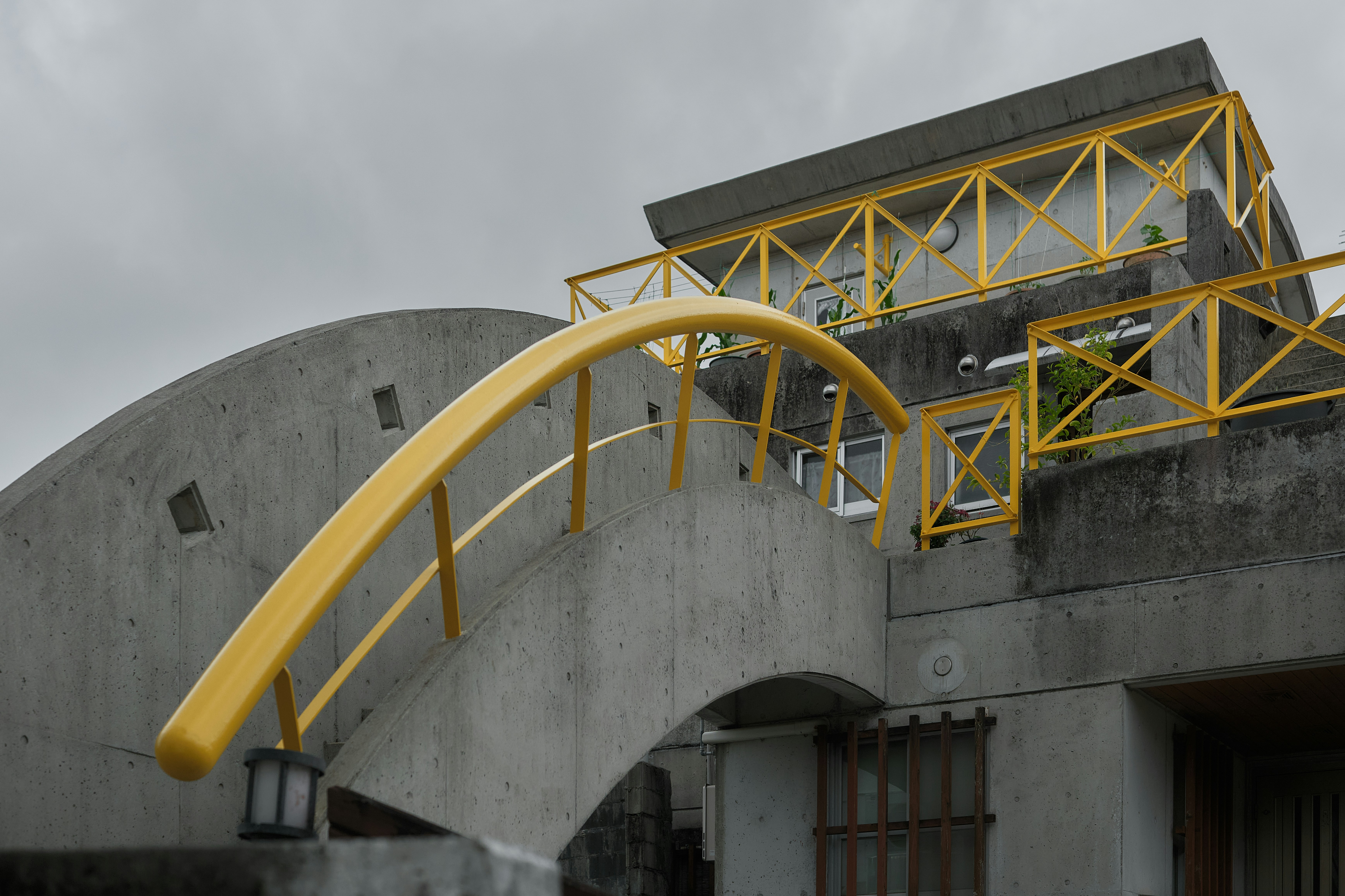 Yellow Arch Against Industrial Concrete