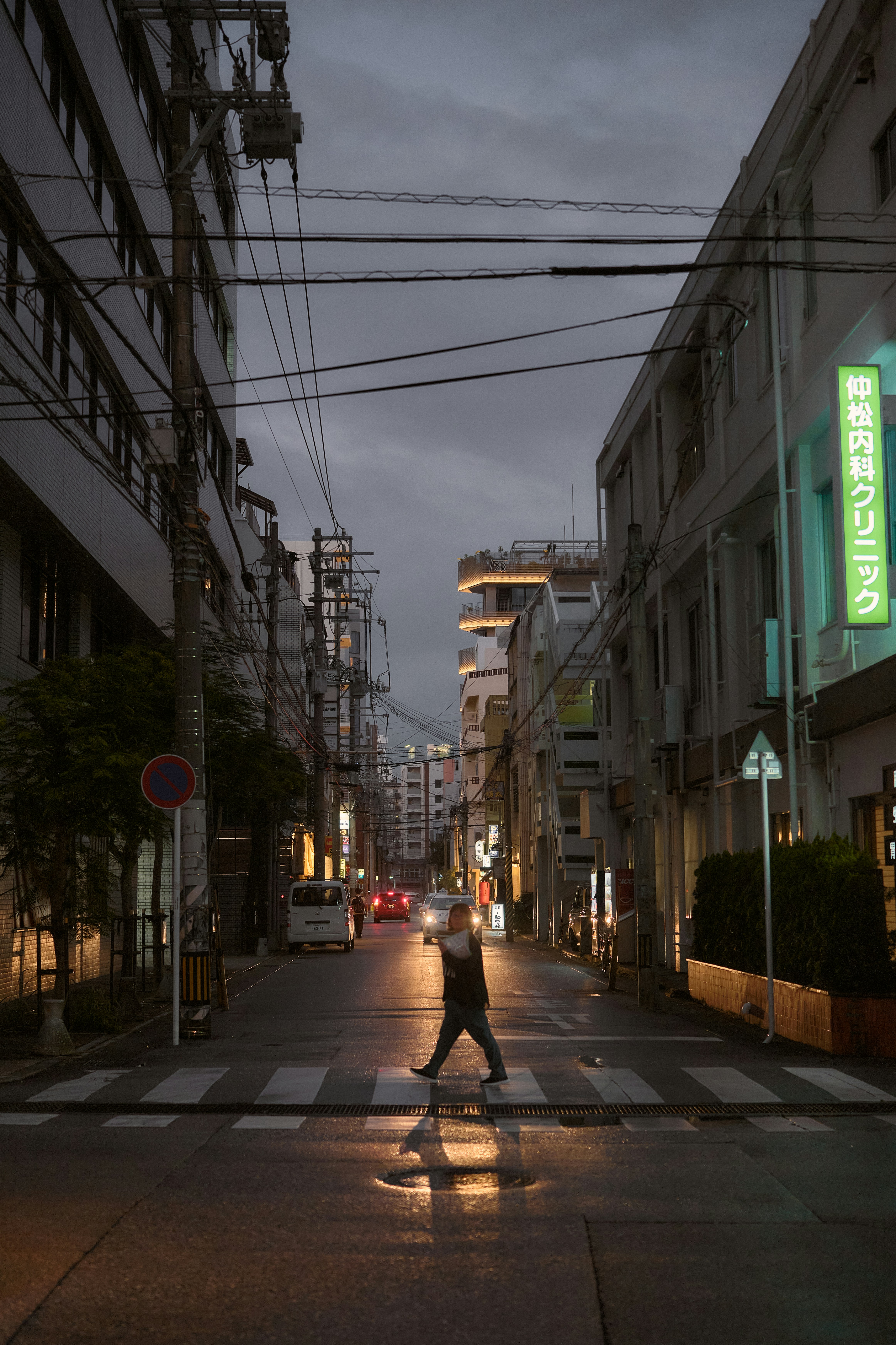 Crosswalk Vigil: A Quiet Evening Amid Neon and Rain