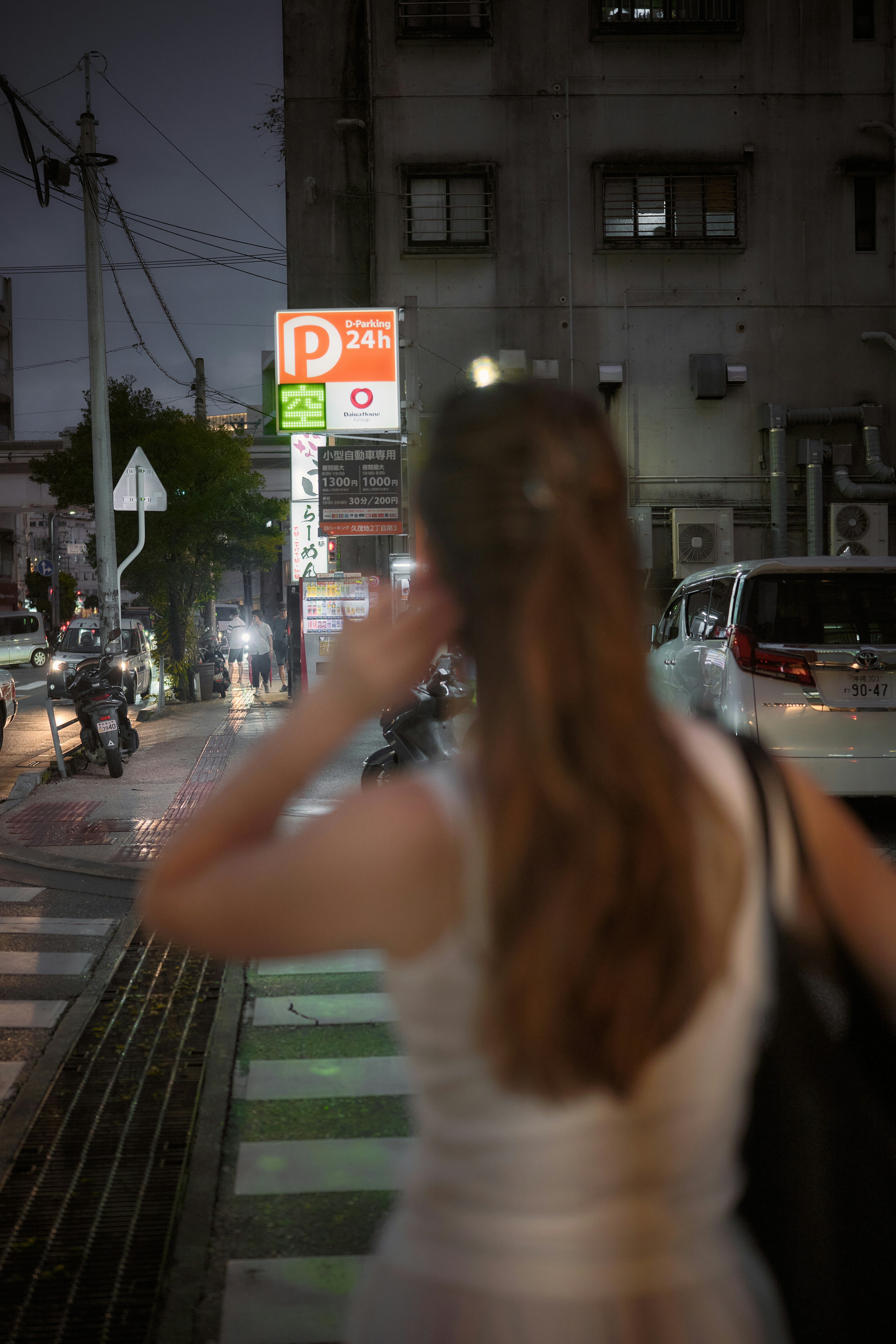 Night Street Pulse: A Woman in Transit Under Neon Signs