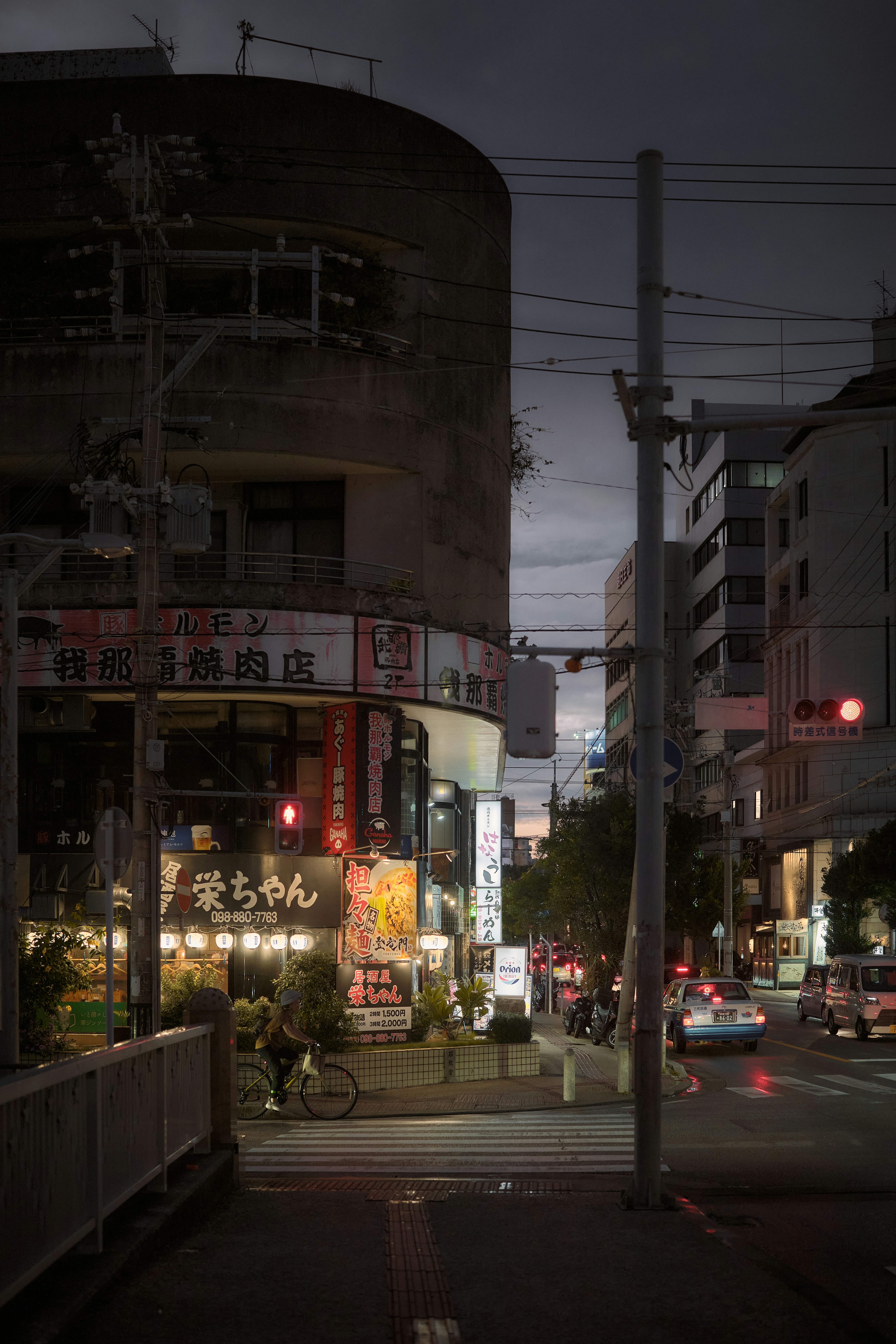 Neon Street Corner: Evening Commerce Under Urban Sky