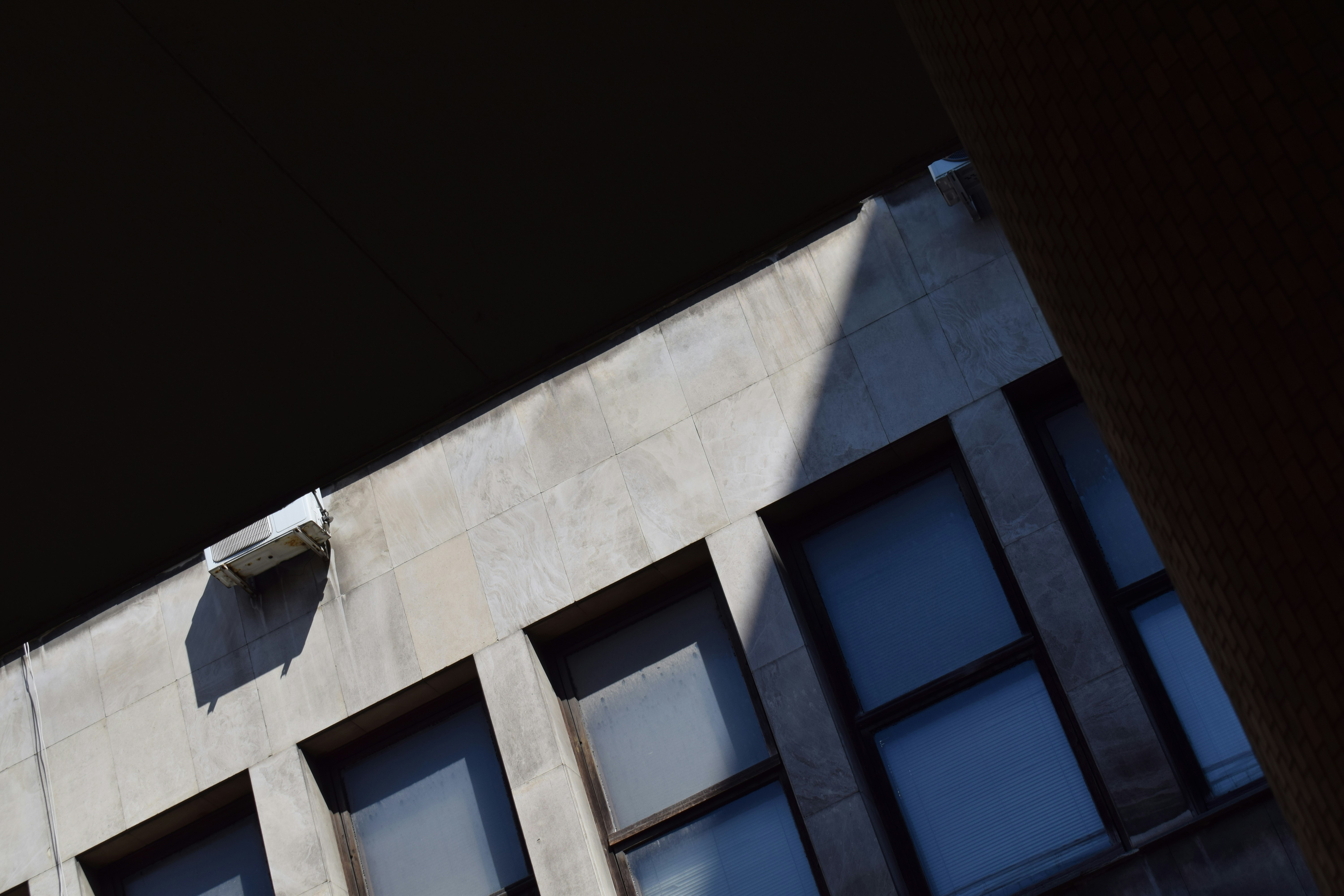 Concrete Angles: Light & Shadow on a Cornered Facade