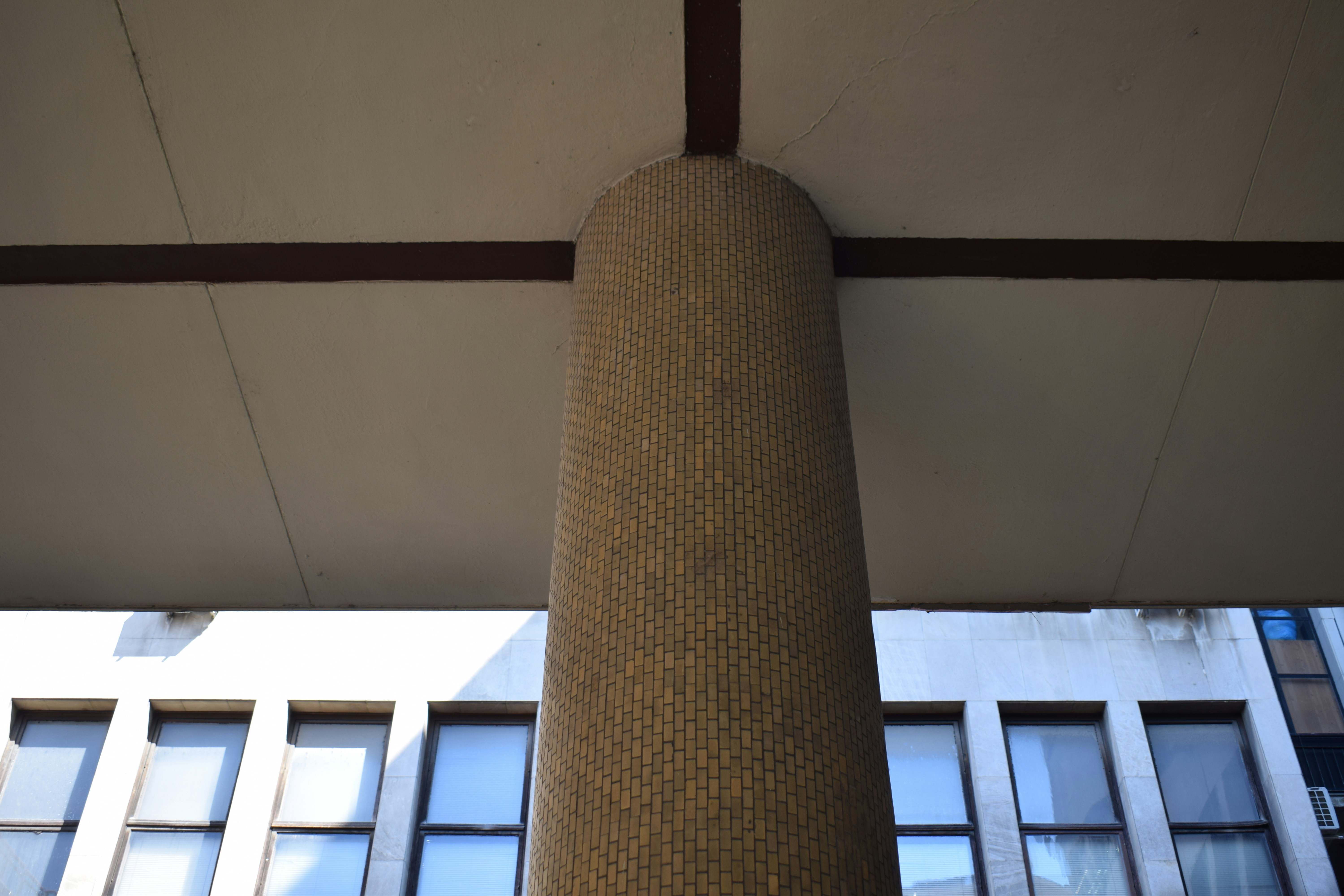 Central Concrete Column Anchoring an Urban Canopy