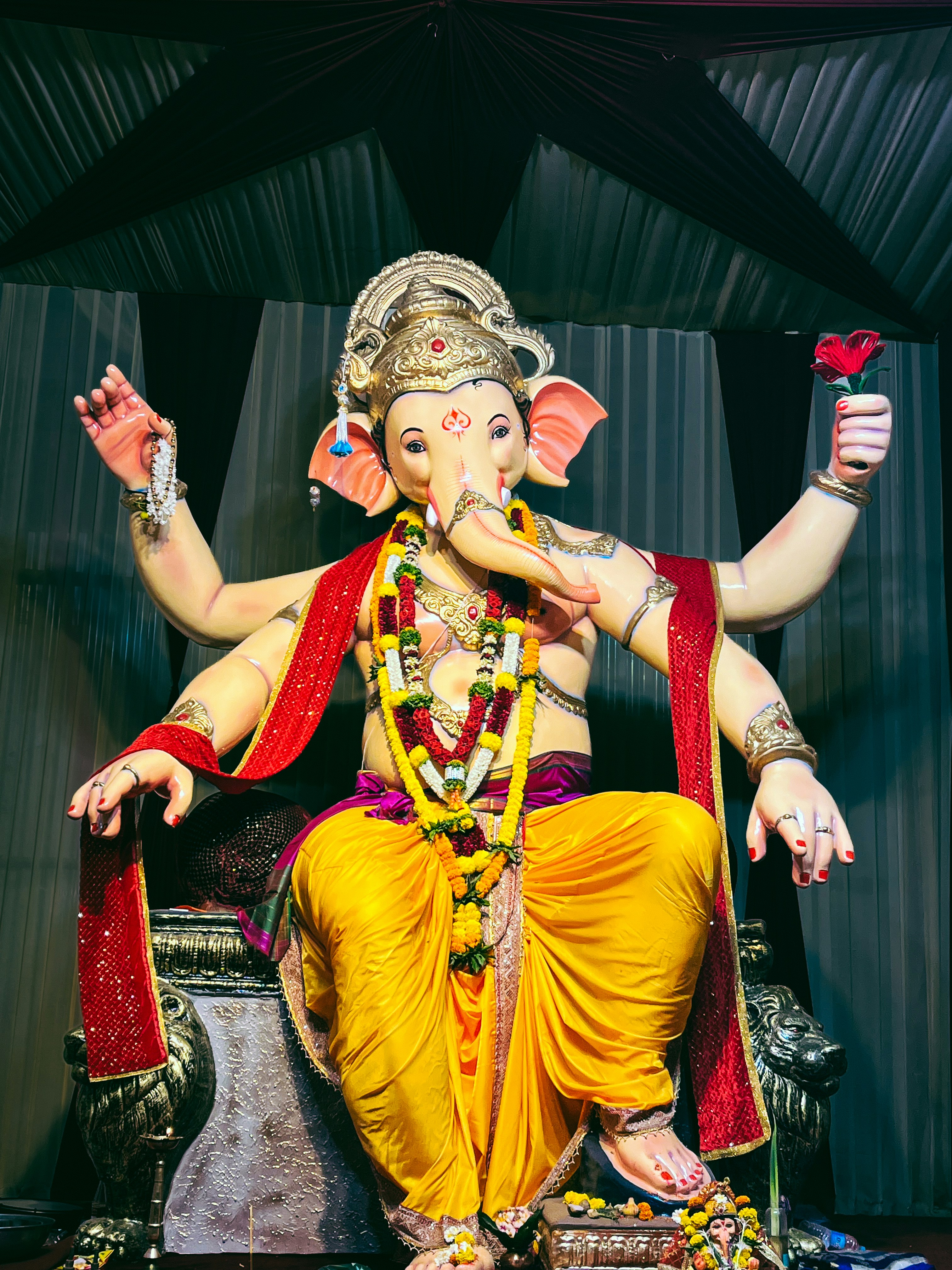 Divine Ganesha on a Throne: Reverent Color and Garment