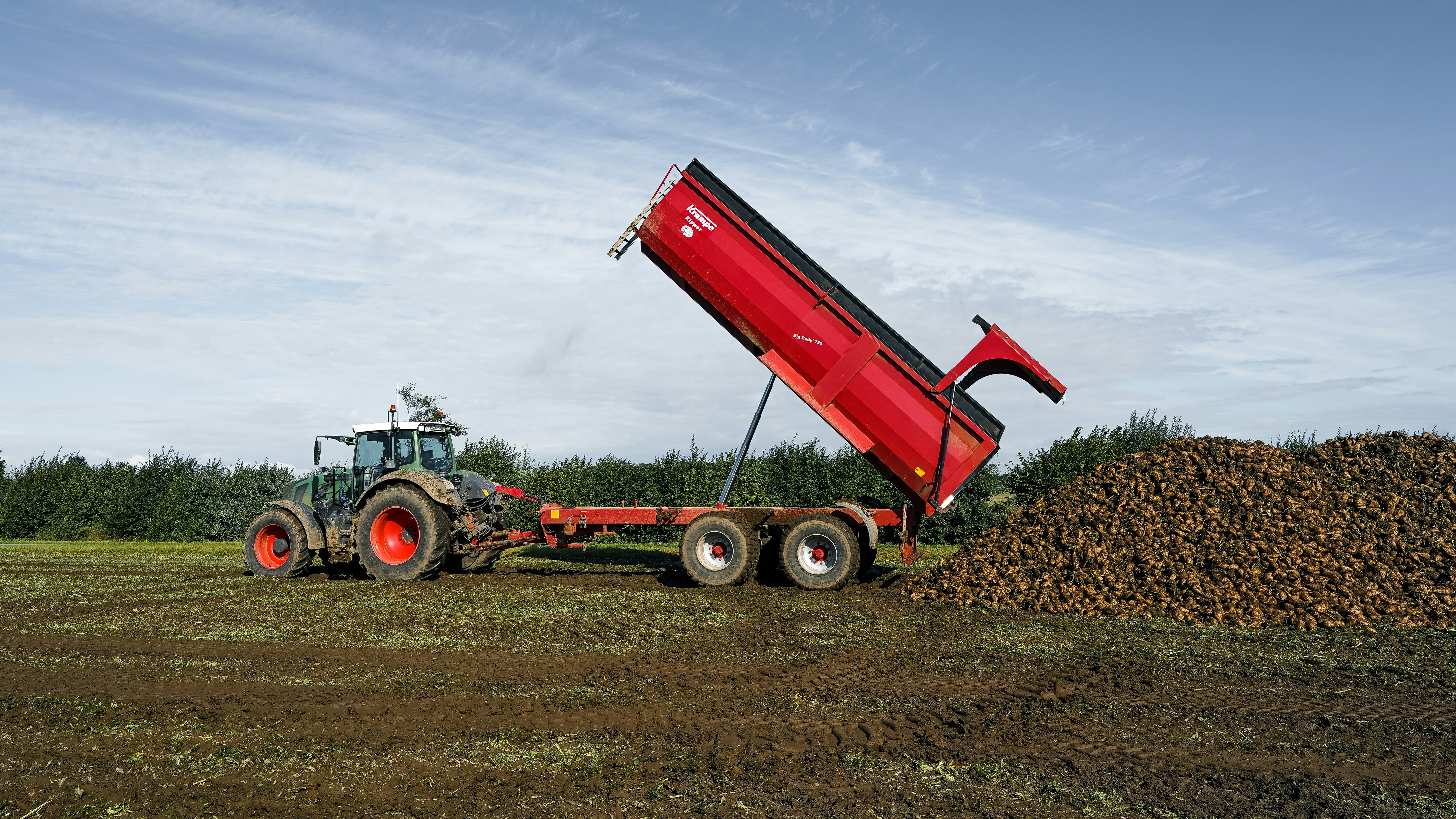 Red Dump Trailer in Mid-Till Landscape