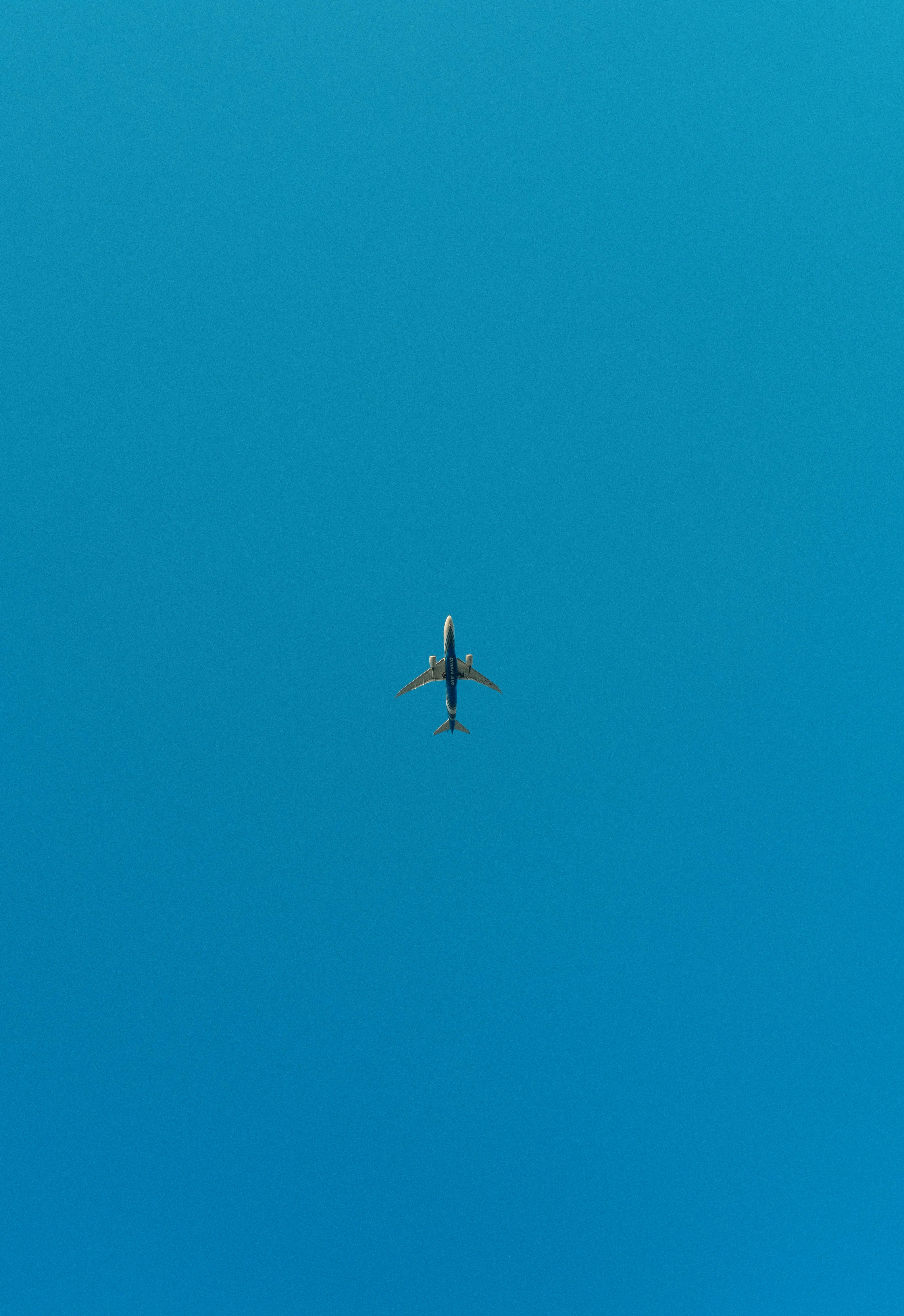 Midair Glide: A Single Jet Against a Vast Blue Sky