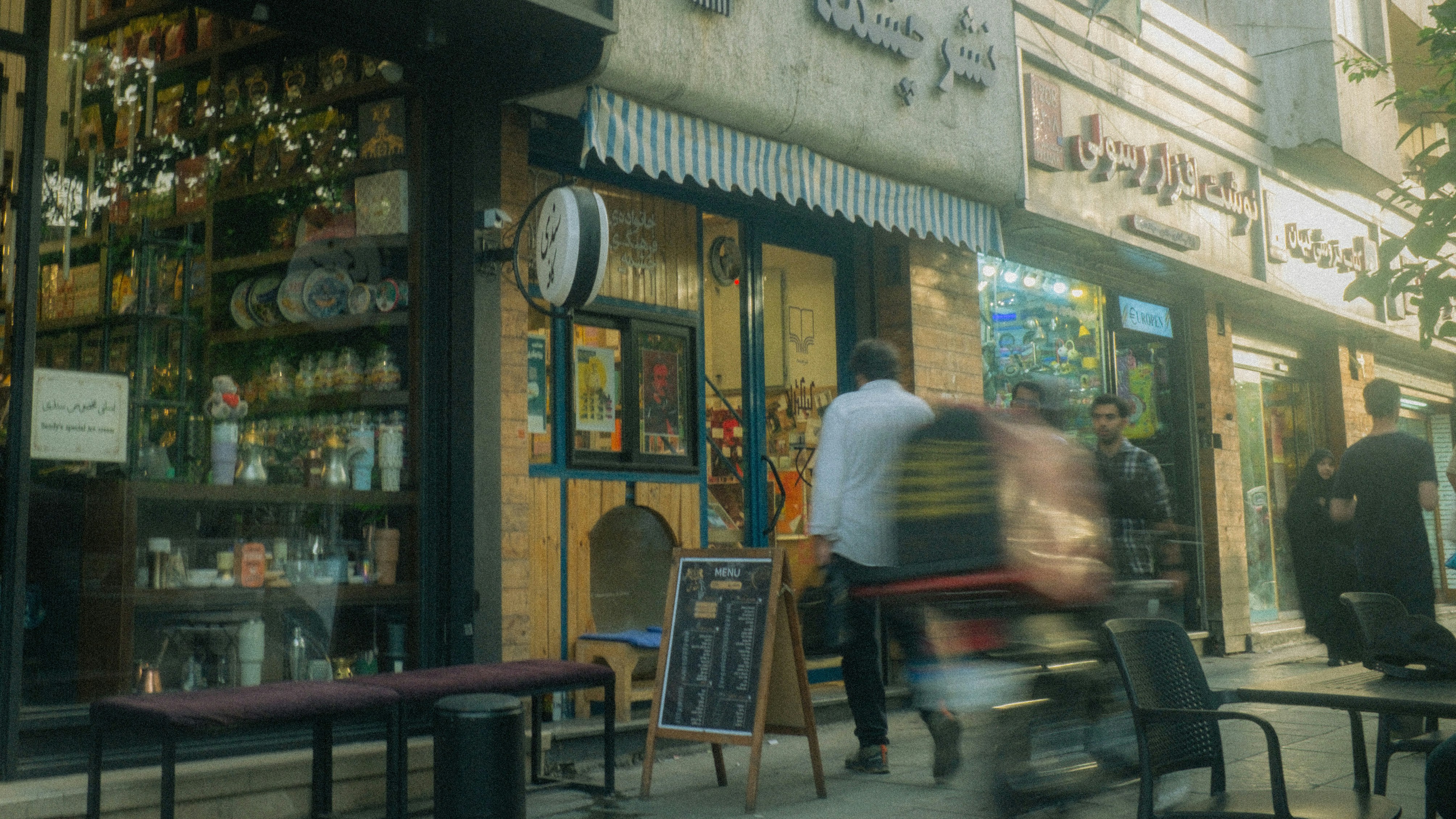 Street-side Cafe Quietly Buzzes as Pedestrians Pass