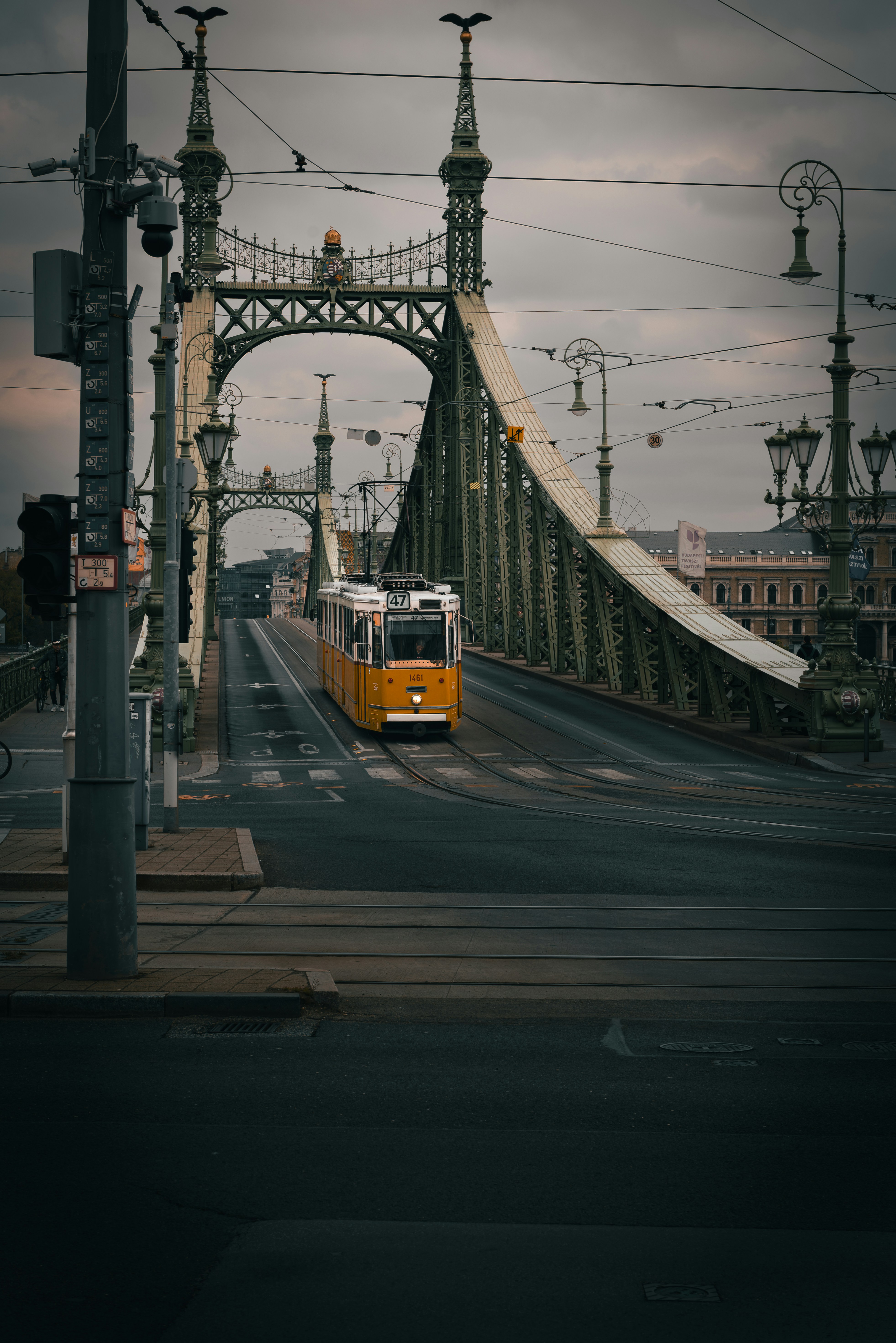 Amber Tram Through the Iron Arch: A City Bridge Snapshot