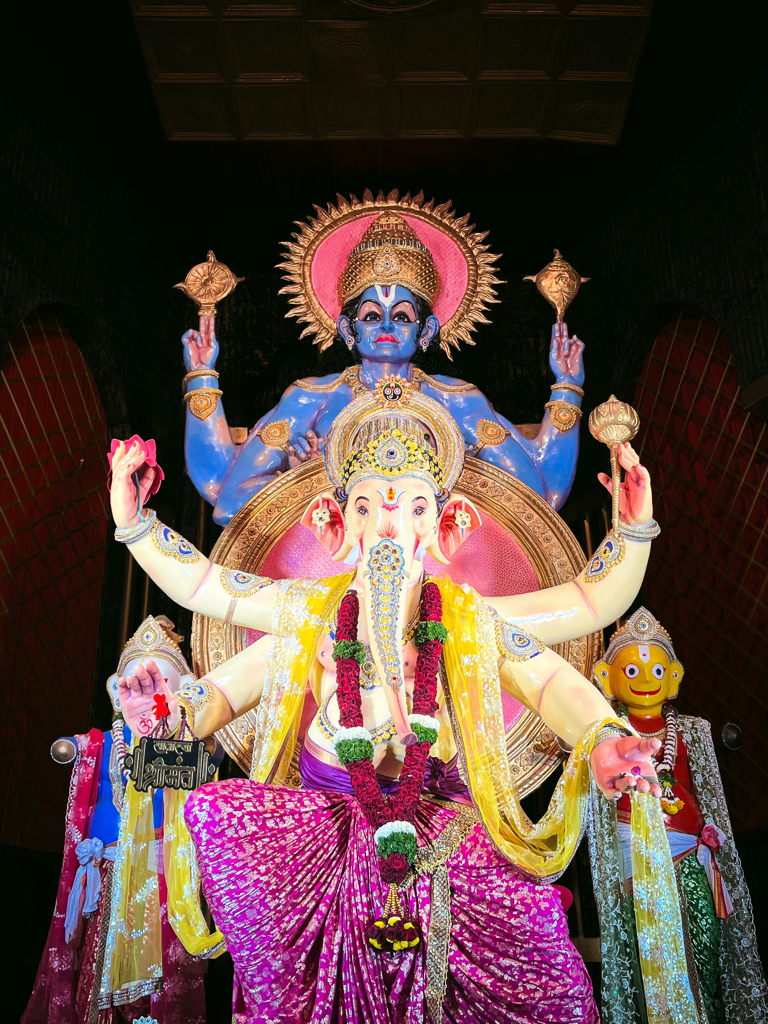 Divine Multitude: The Blue-Vermilion Form in Reverent Pose