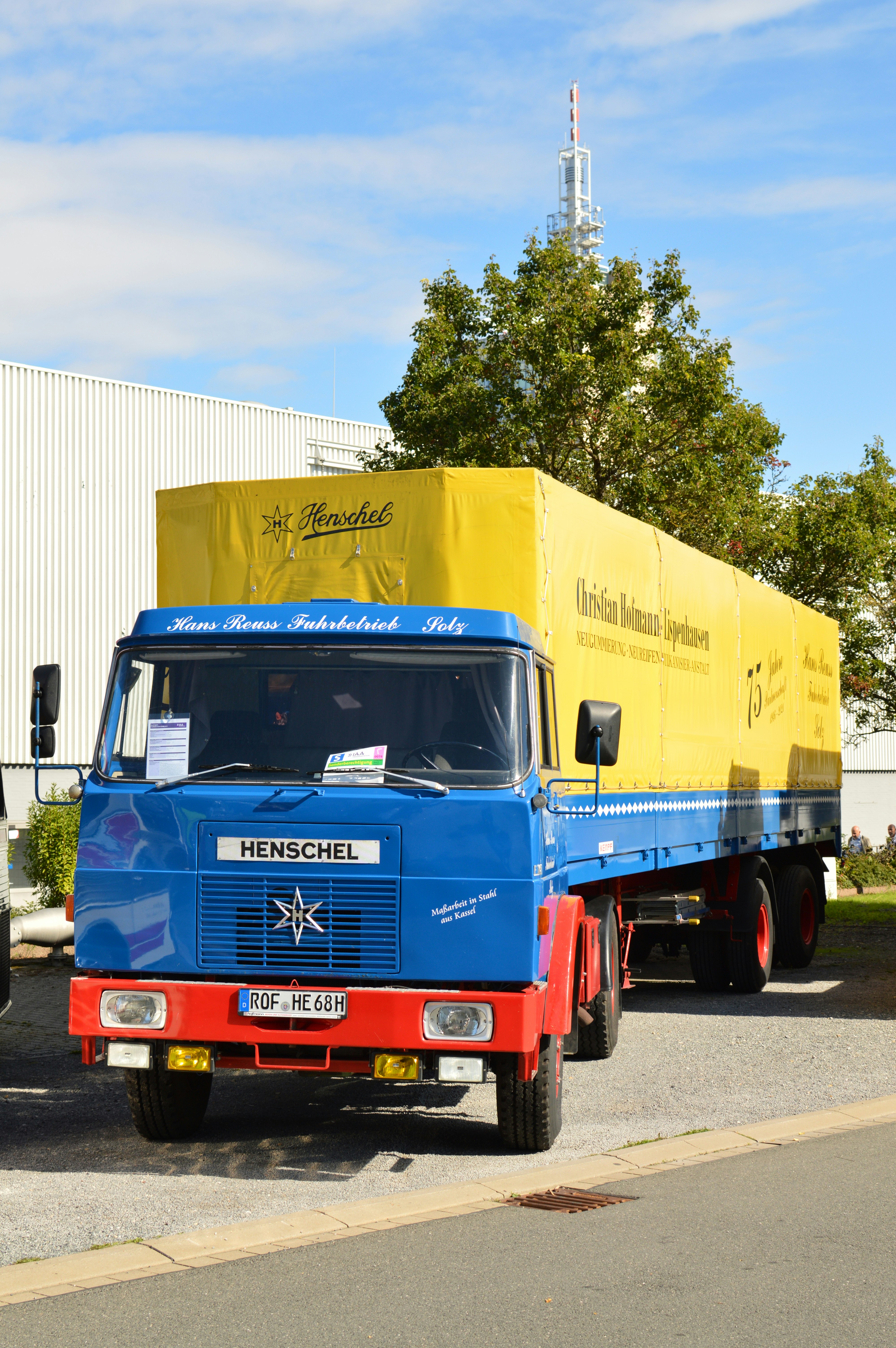 Blue Hauls and Yellow Canopy: A Freight Truck in Focus