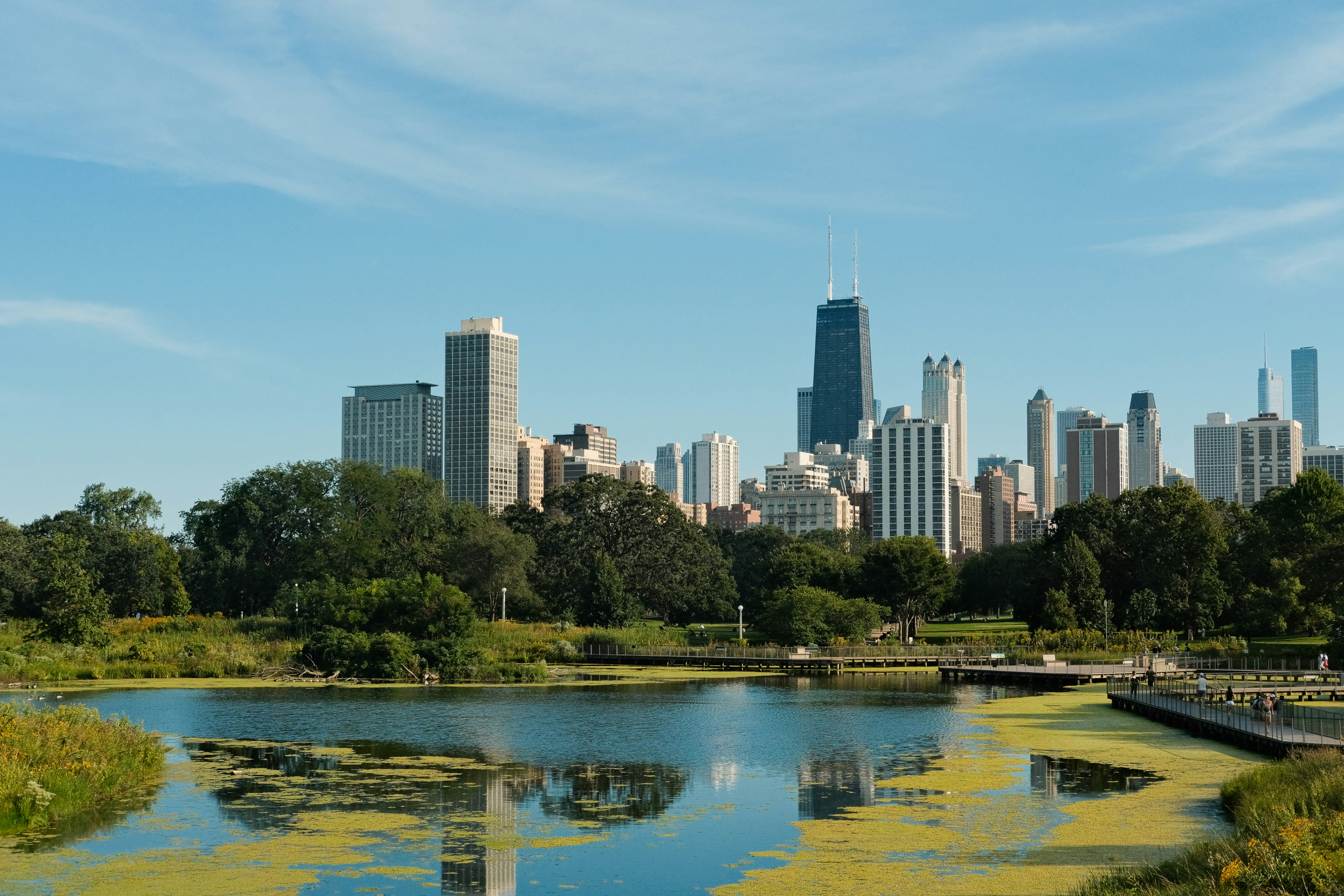 Cityscape Reflections: A Calm Dawn Over the Lake