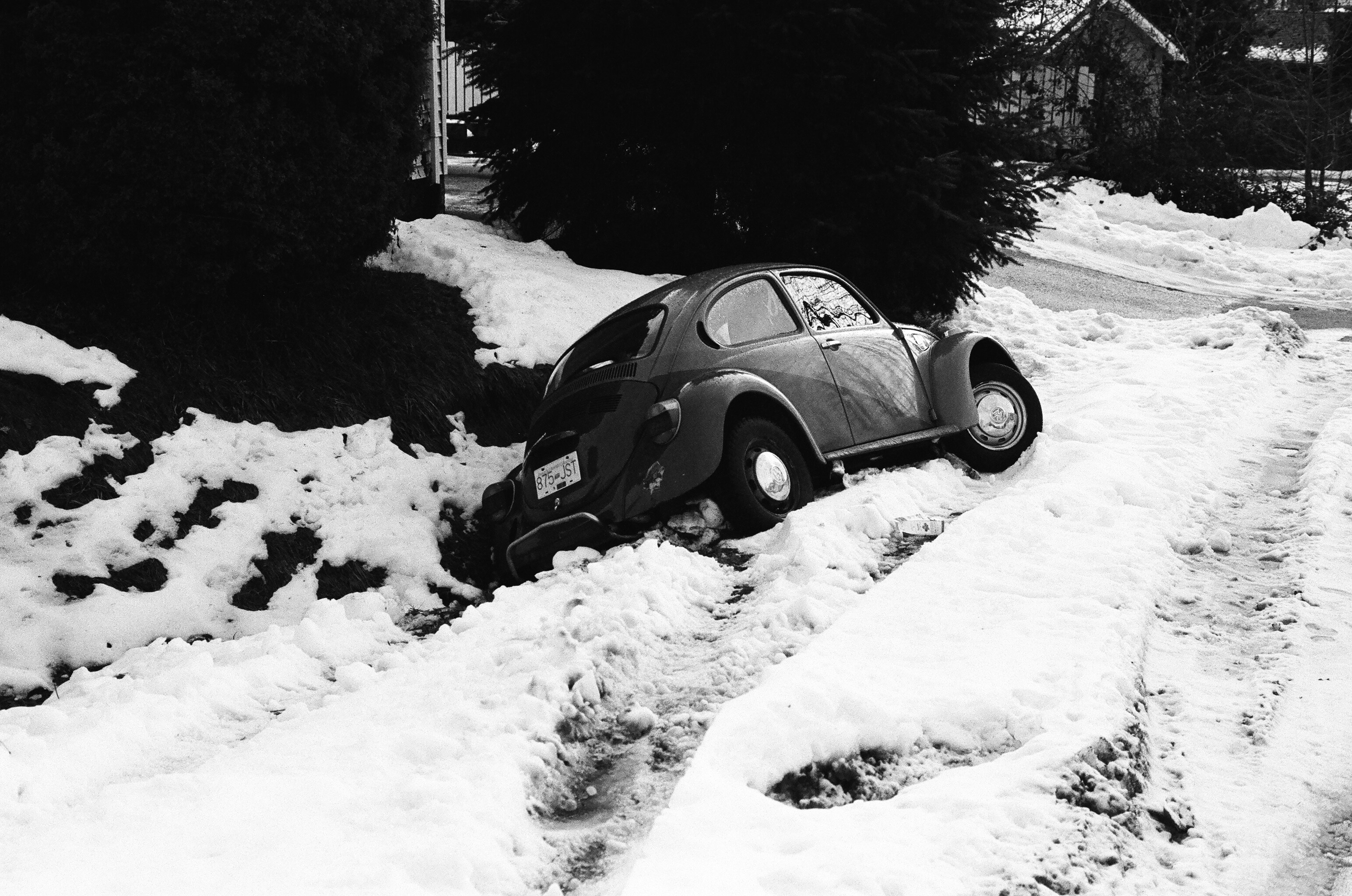 Snowbound Beetle: a vintage VW teeters in a white drift